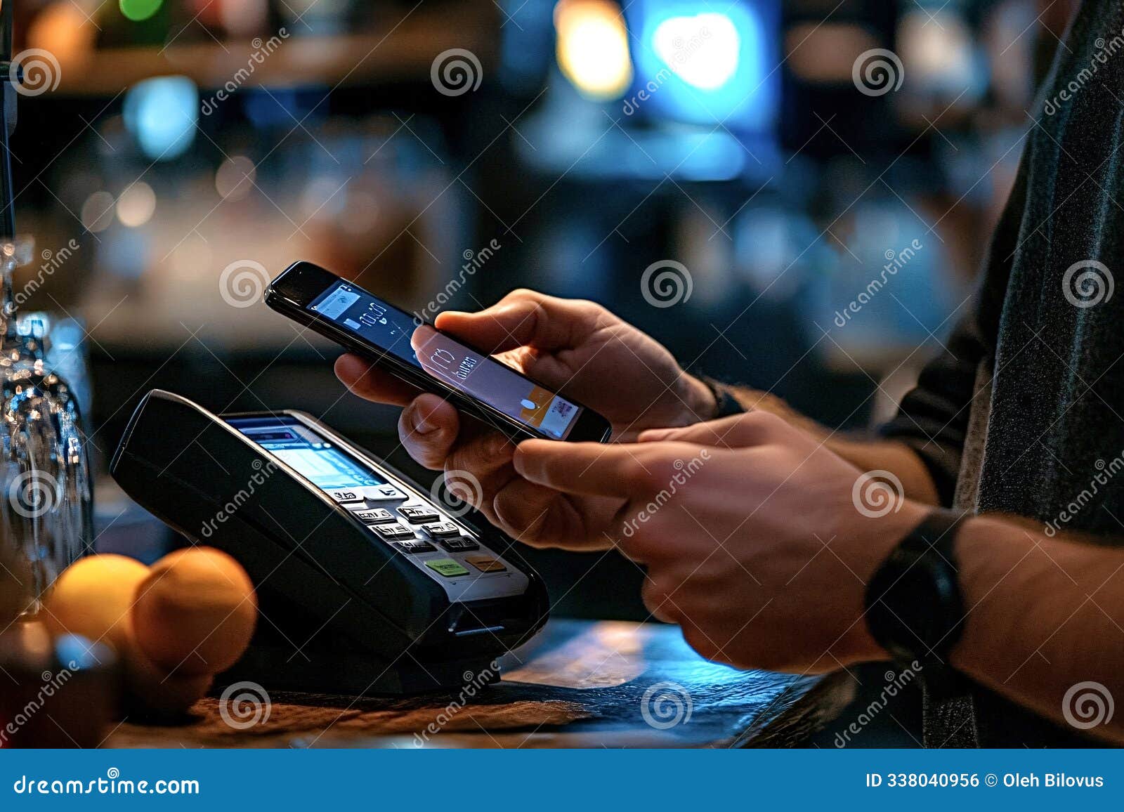 Customer Using Smartphone To Make Contactless Payment in Bar Stock ...