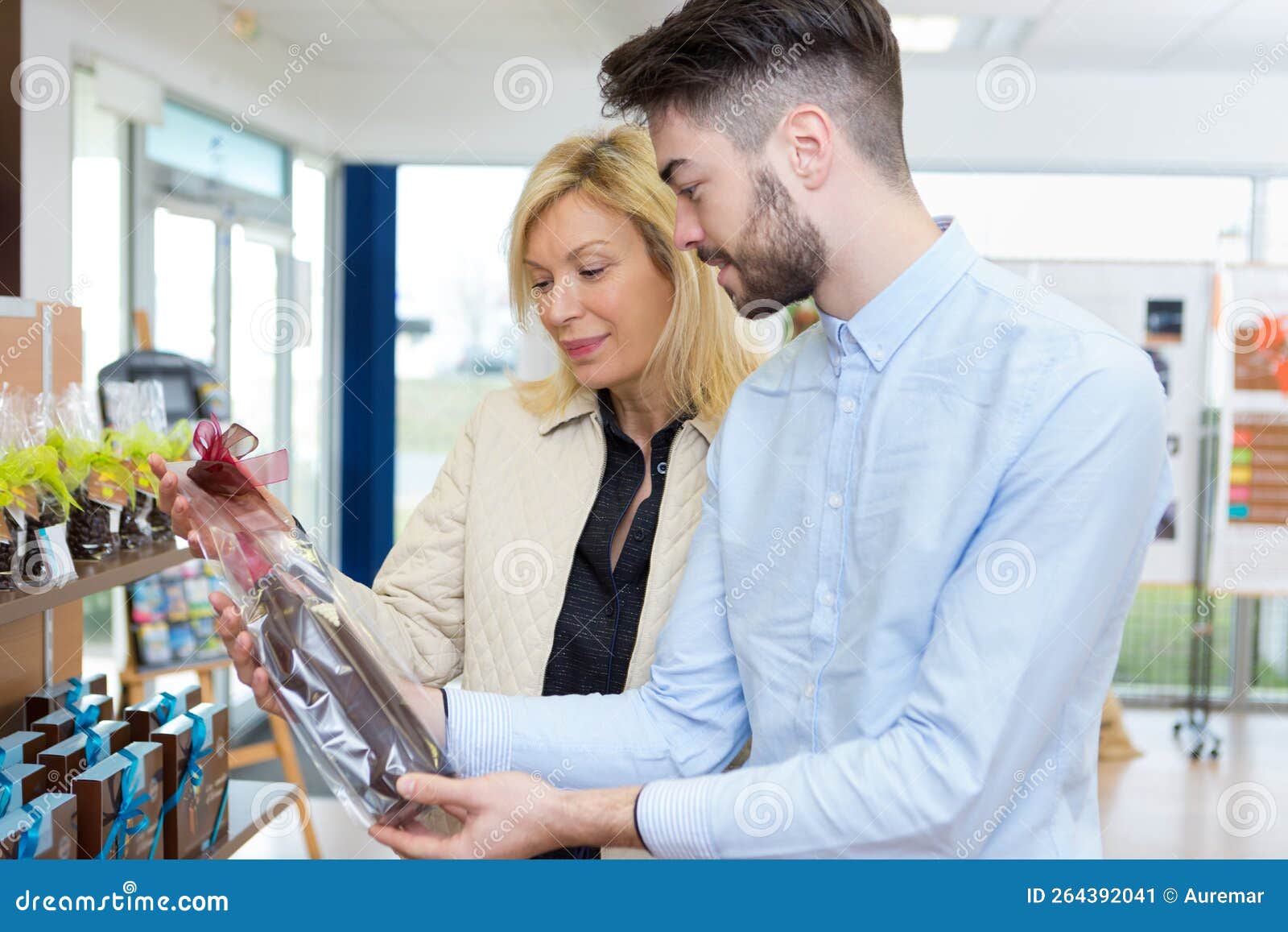 Customer Looking at Bottle Shaped Chocolate Gift in Store Stock Image ...