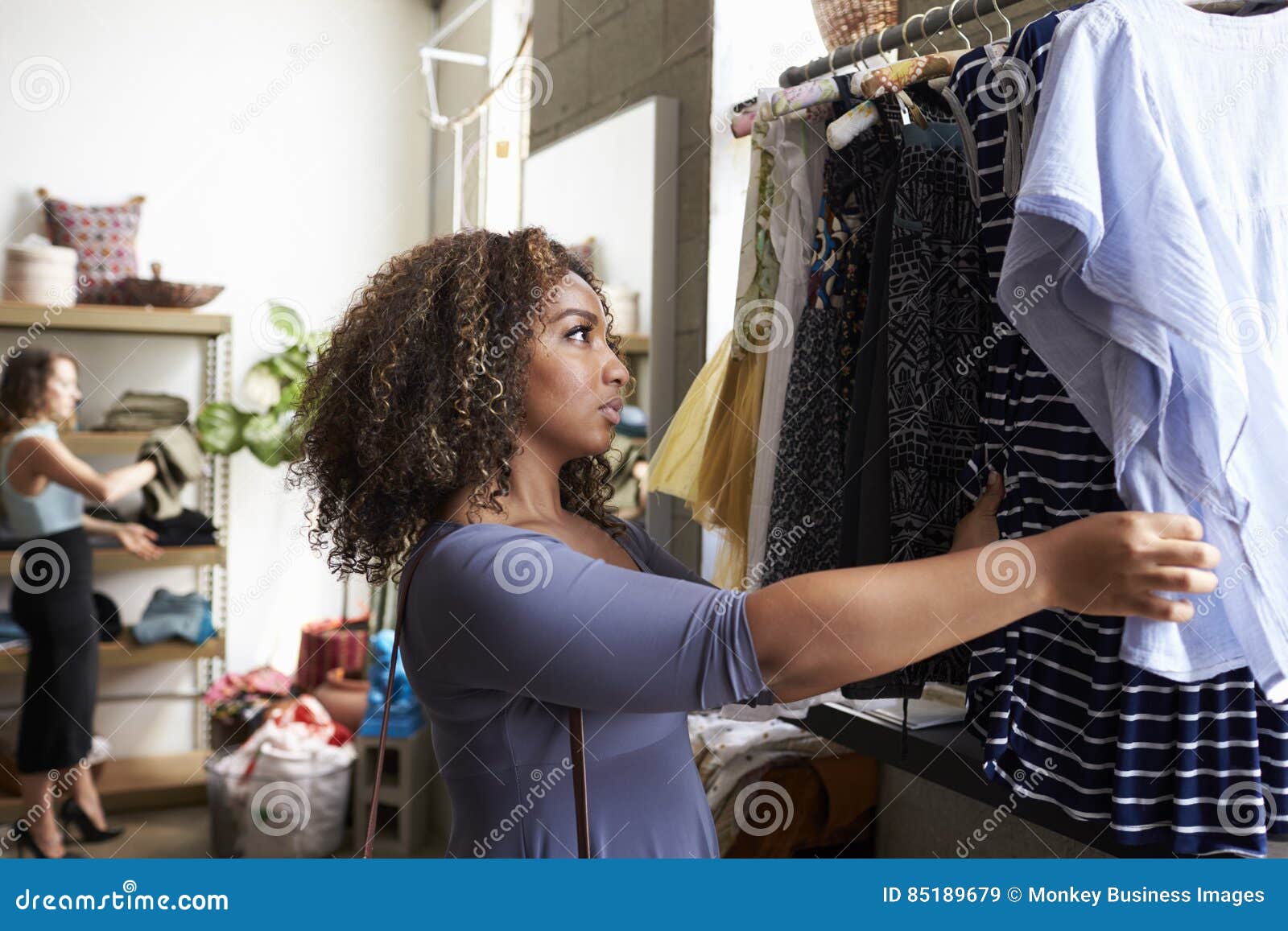 Customer Looking at Clothes on a Hanging Rail in a Boutique Stock Image ...