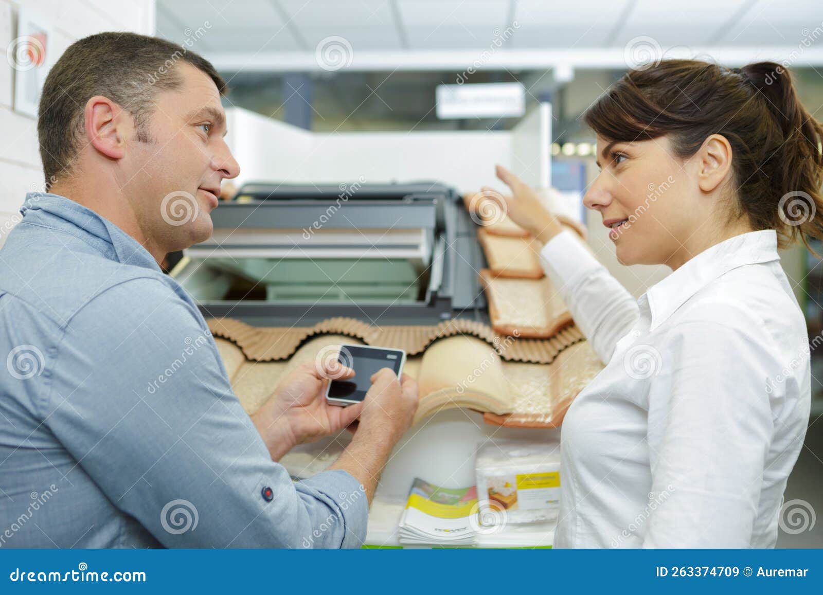 Customer Looking at Roof Light Display in Builders Merchant Store Stock ...