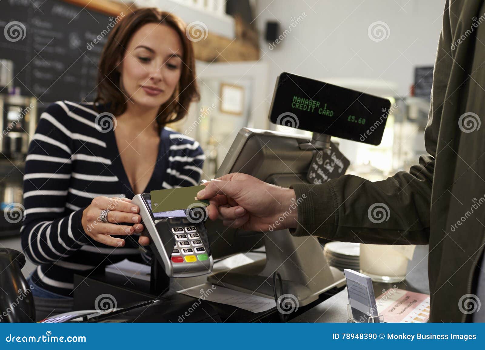 Customer Making a Contactless Card Payment Over Shop Counter Stock ...