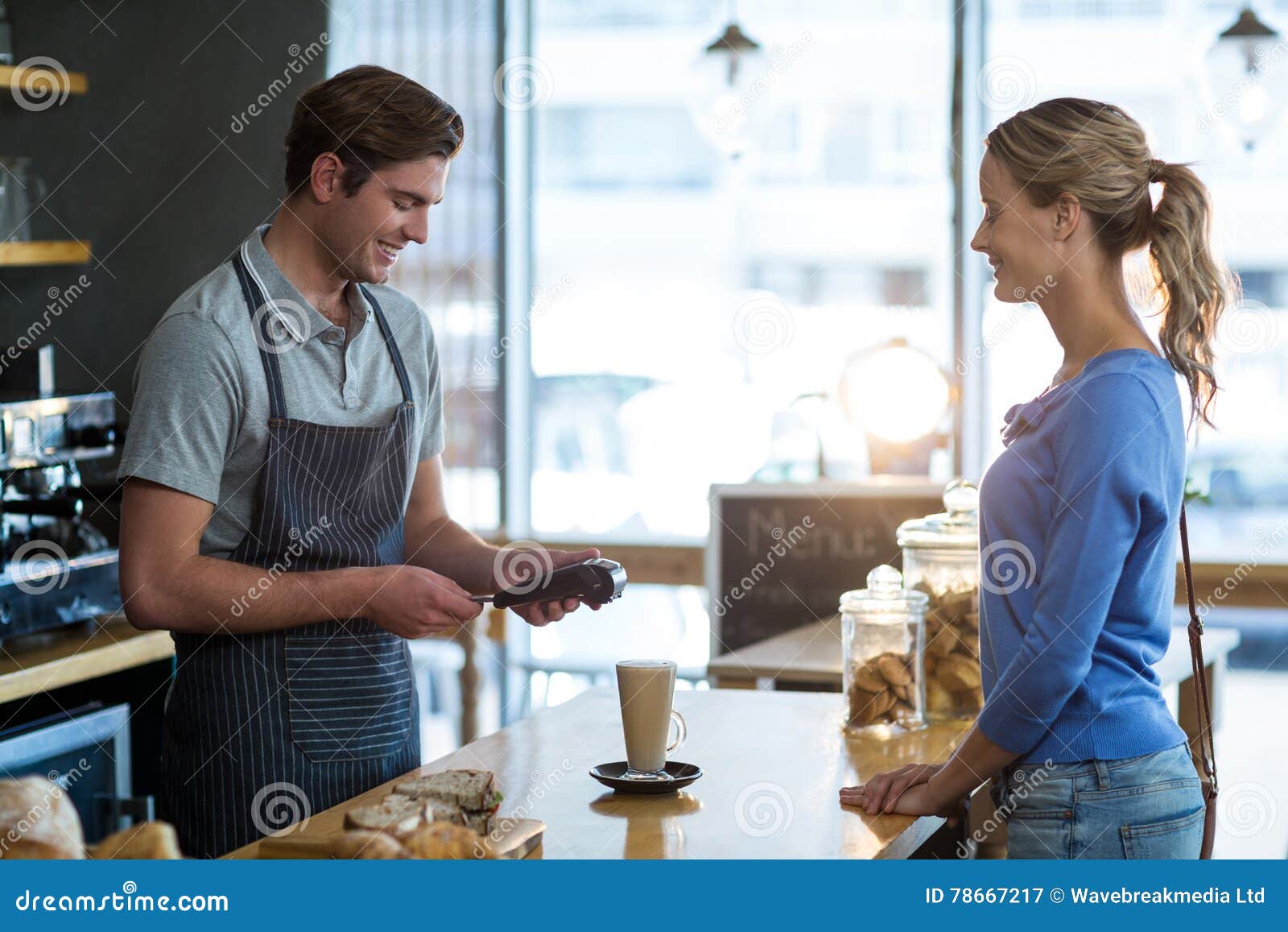 Customer Making Payment through Payment Terminal at Counter Stock Image ...