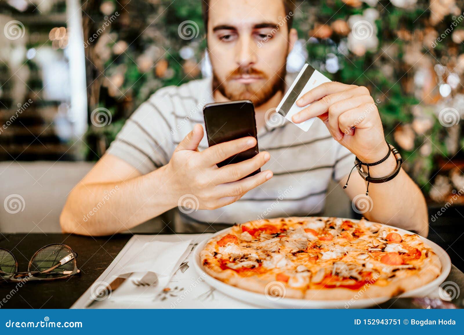 Customer Making Payment Using Credit Card and Smartphone. Modern ...