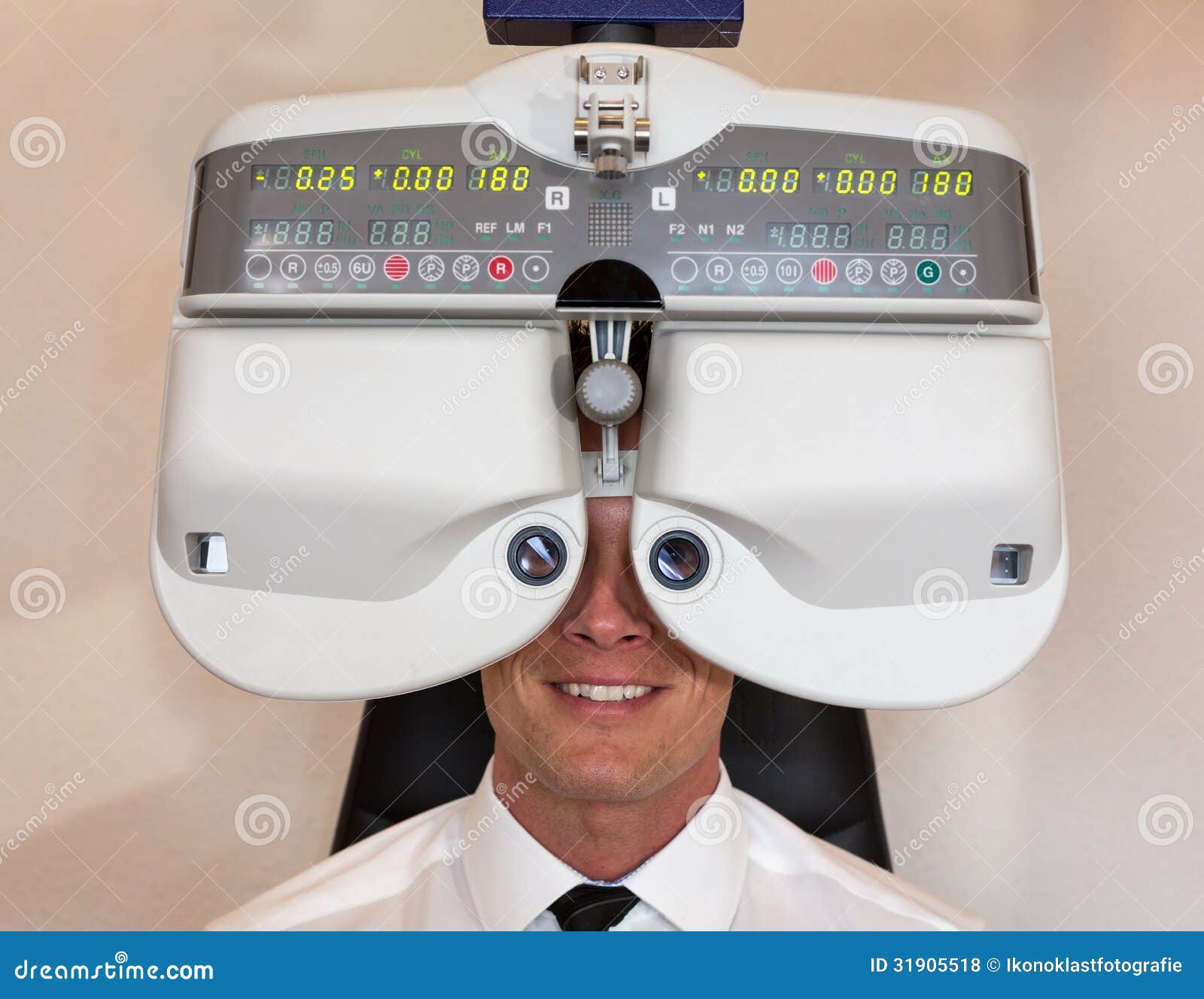 Customer of a Optometrist or Optician Looking through Phoropter Stock ...