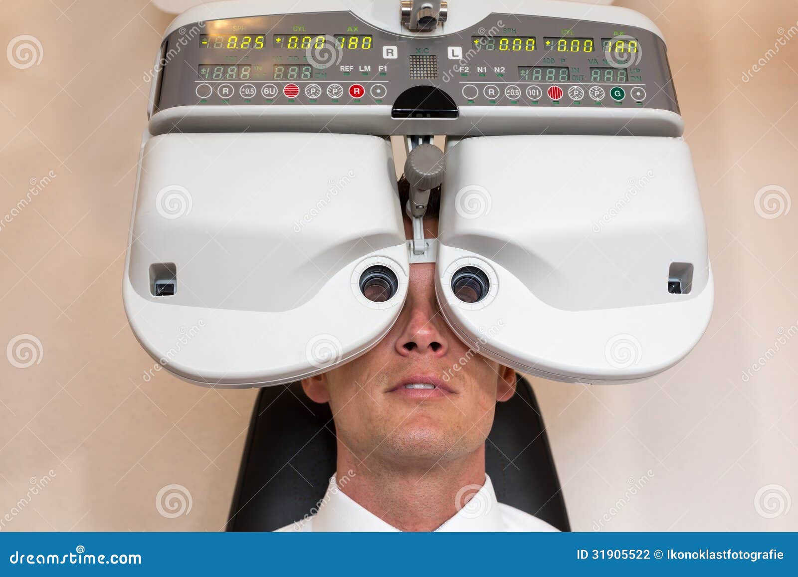 Customer of a Optometrist or Optician Looking through Phoropter Stock ...