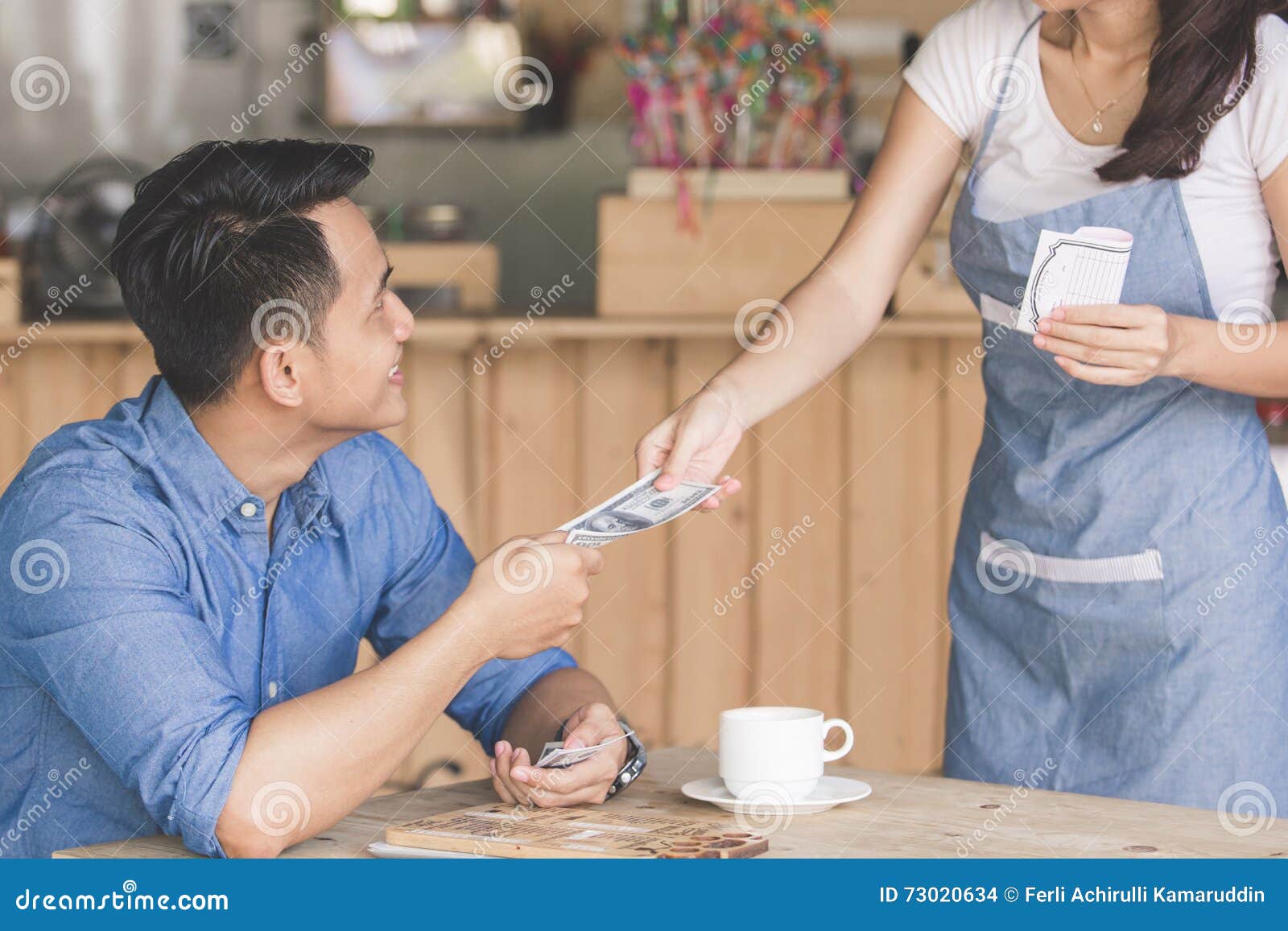 Customer paying by cash stock photo. Image of apron, female - 73020634