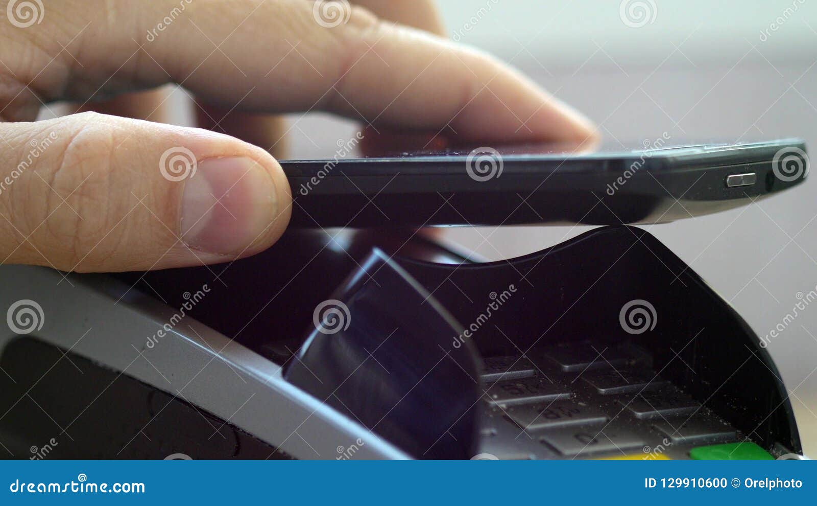 Customer Paying with NFC Technology by Mobile Phone on POS Terminal ...