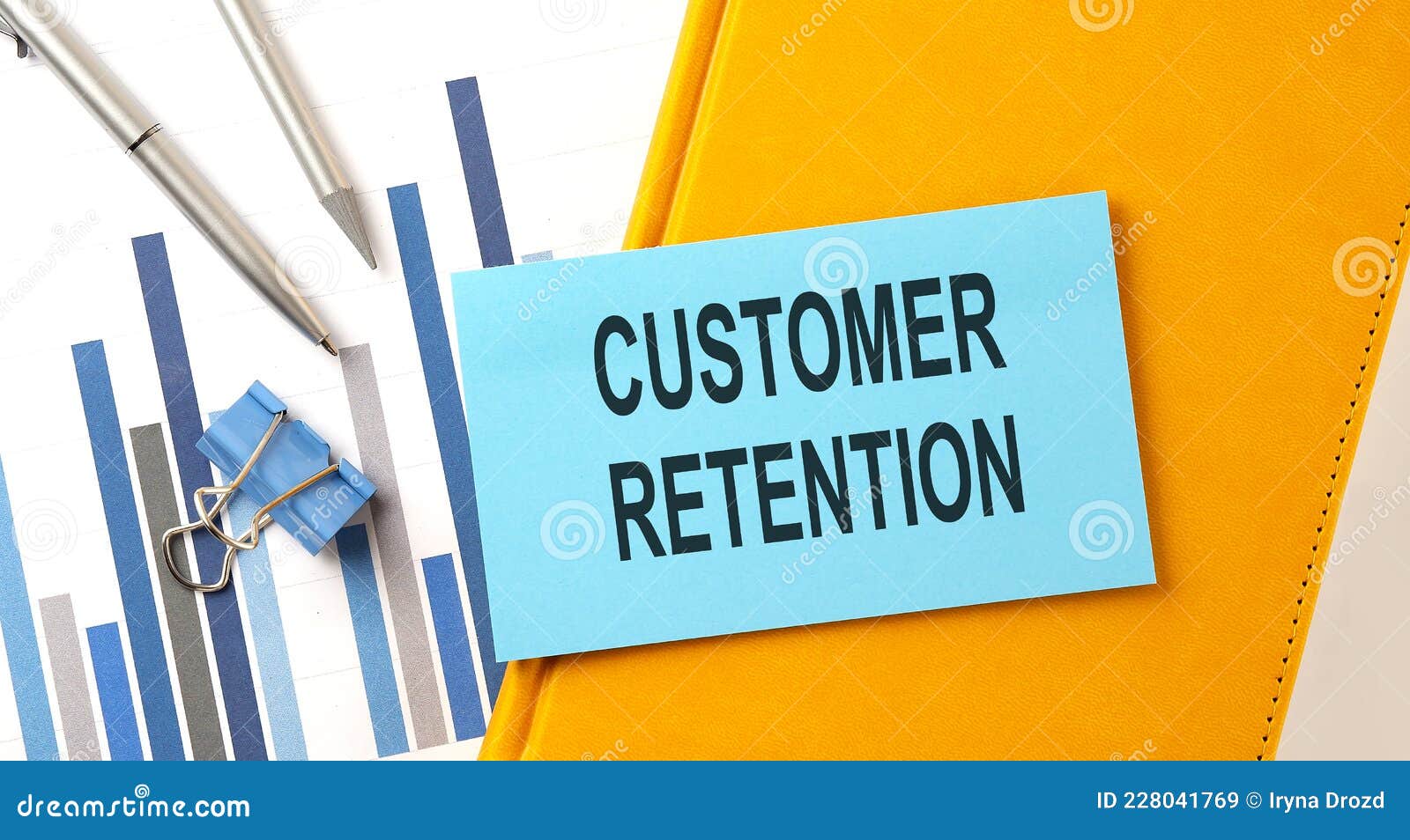 CUSTOMER RETENTION Text on Sticker on the Yellow Notebook with Chart ...