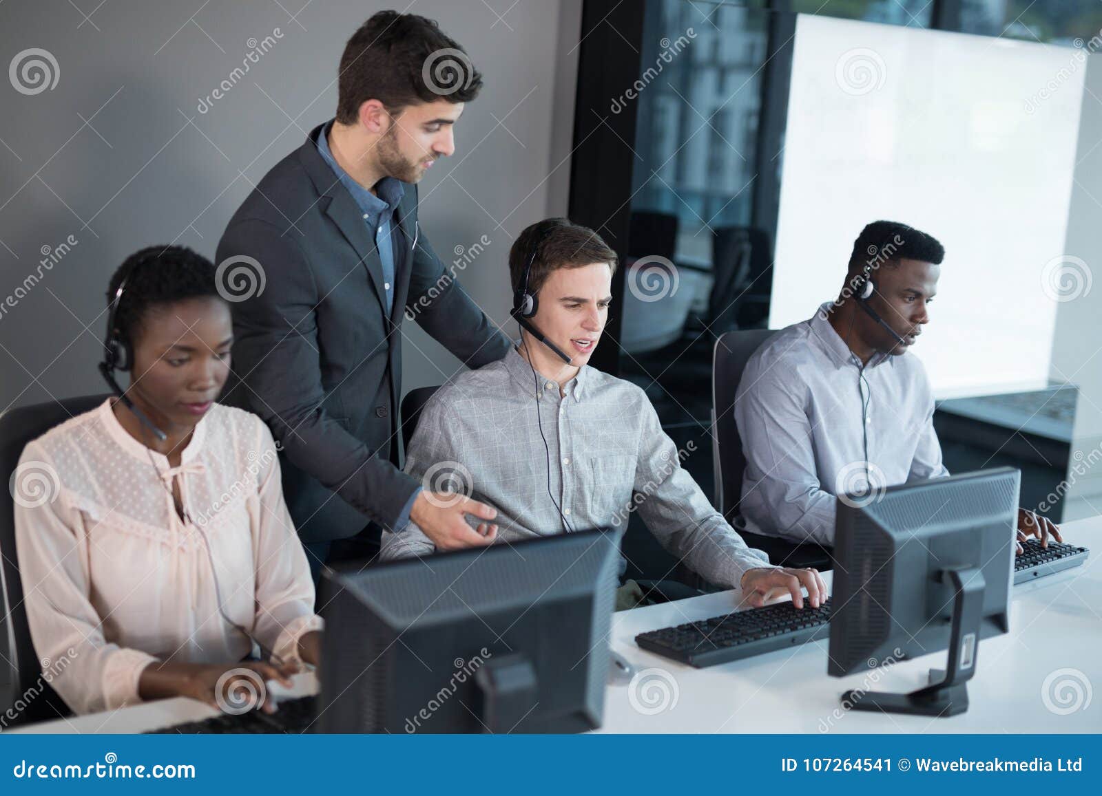 Customer Service Executive Trainer Monitoring Her Team Stock Image