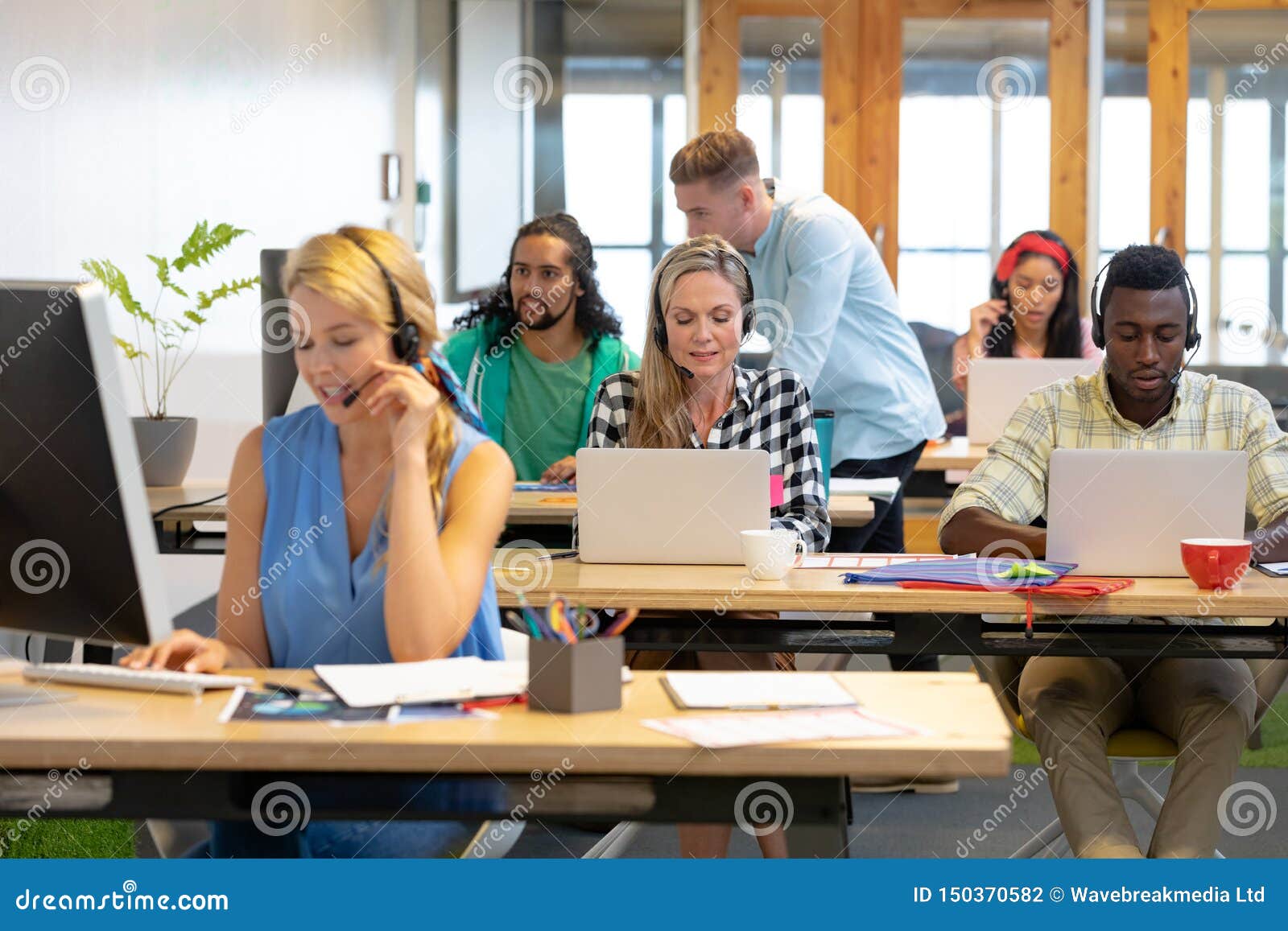 Customer Service Executives Working at Desk in a Modern Office Stock ...