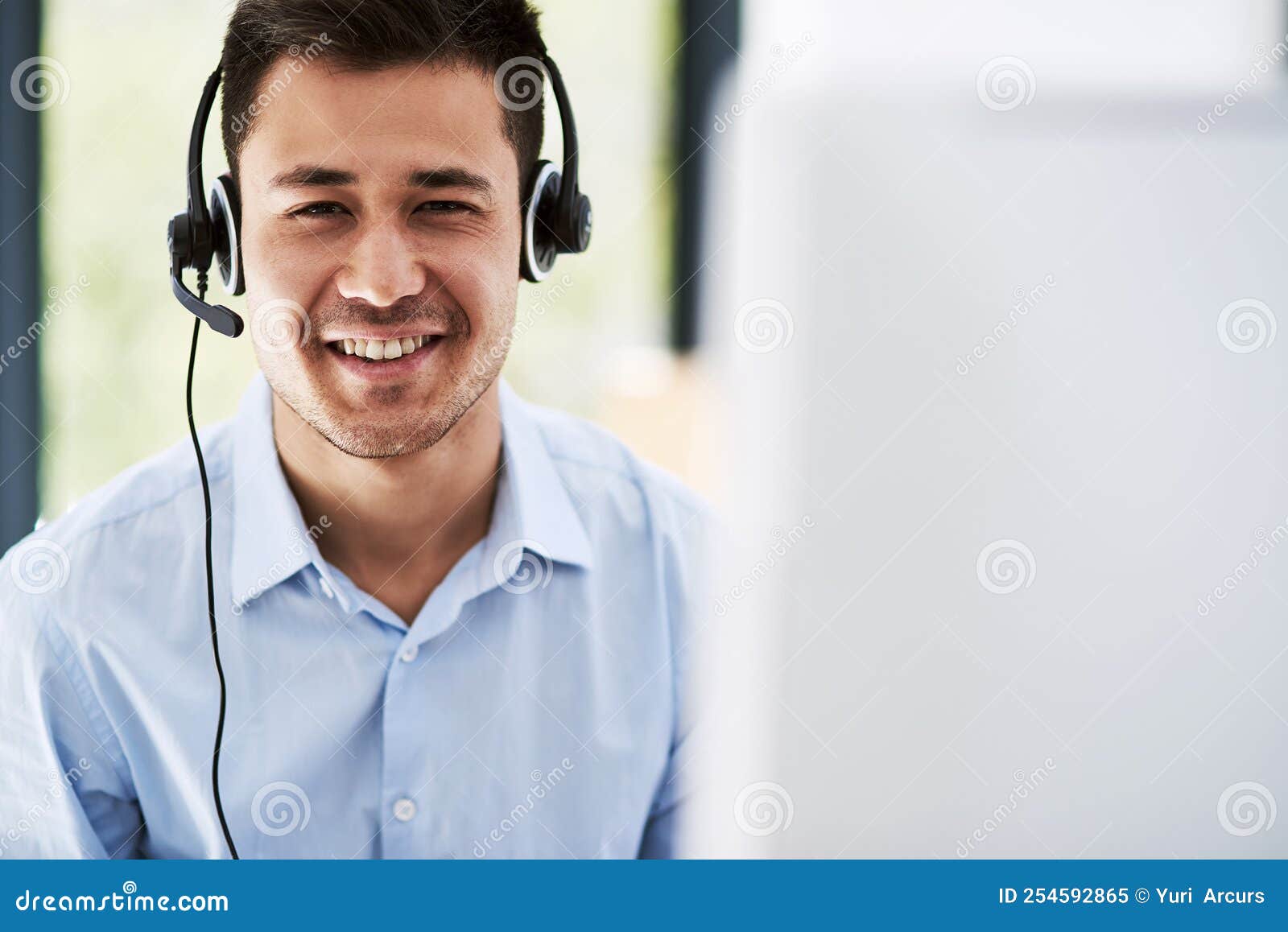 Customer Service is My Priority. Portrait of a Happy Young Man Wearing ...