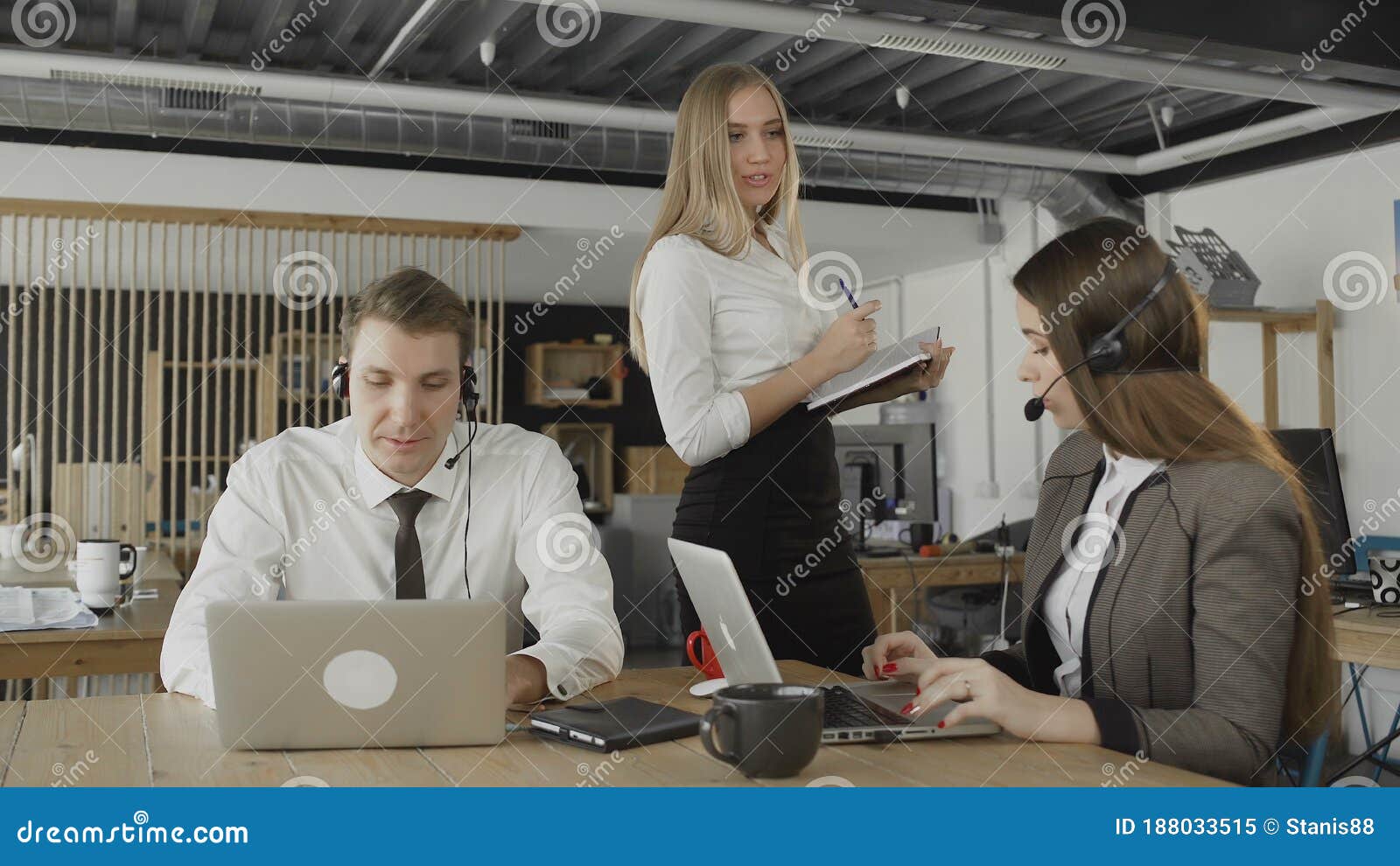 Customer Service Operators Taking Calls in Busy Call Center, Manager ...