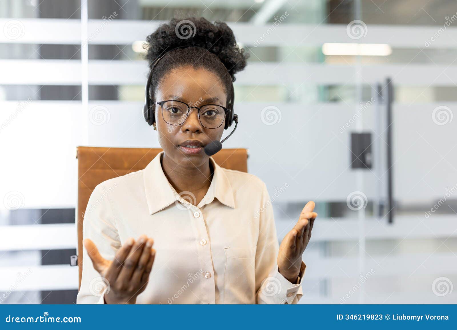 Customer Service Representative with Headset Engaged in Virtual Meeting ...