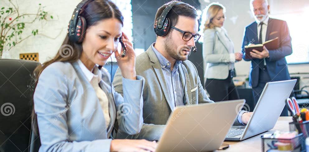 Customer Support Operators Working on Laptops in Modern Office. Stock ...