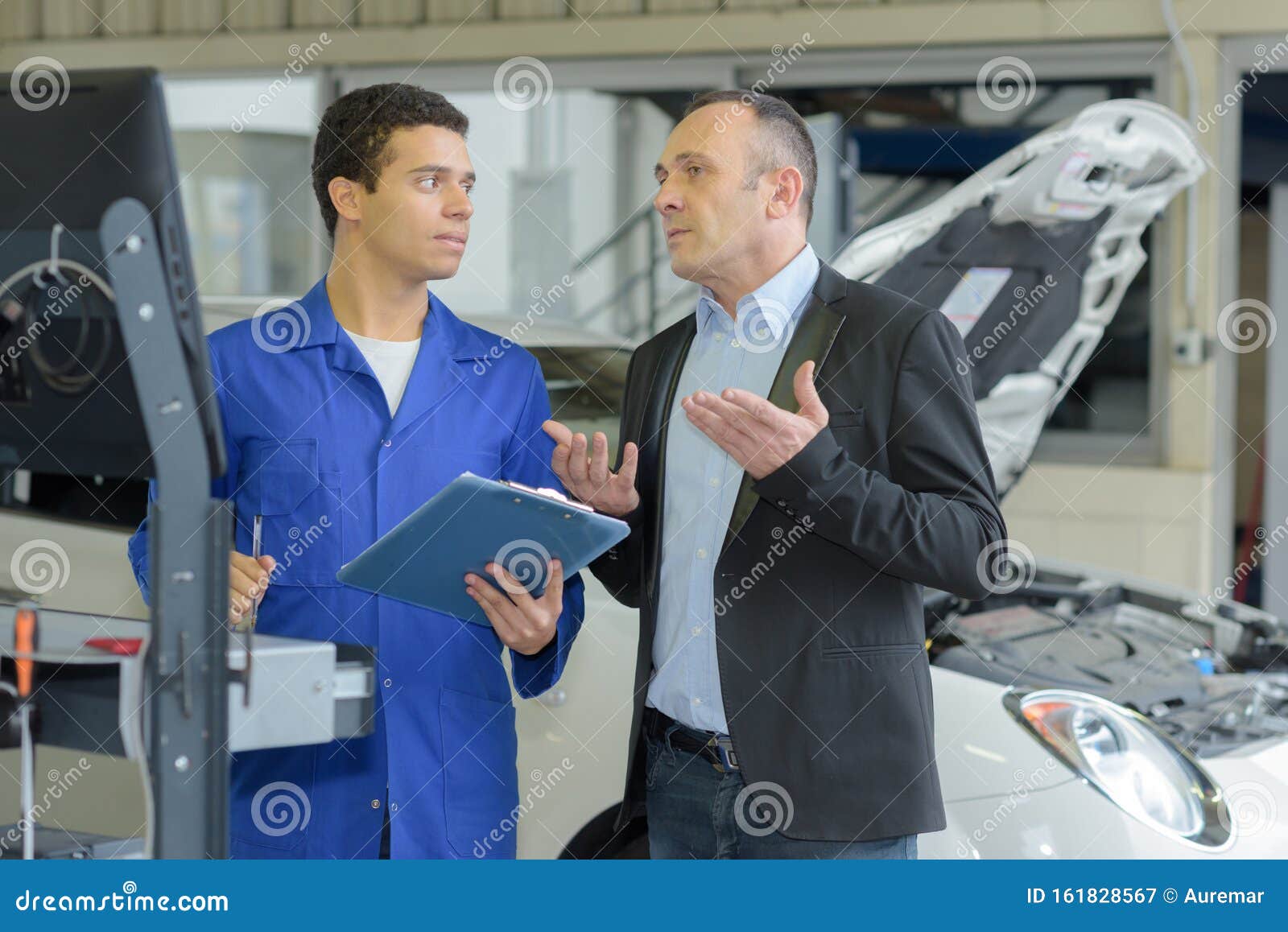 Customer Talking To Young Garage Mechanic Stock Image - Image of ...