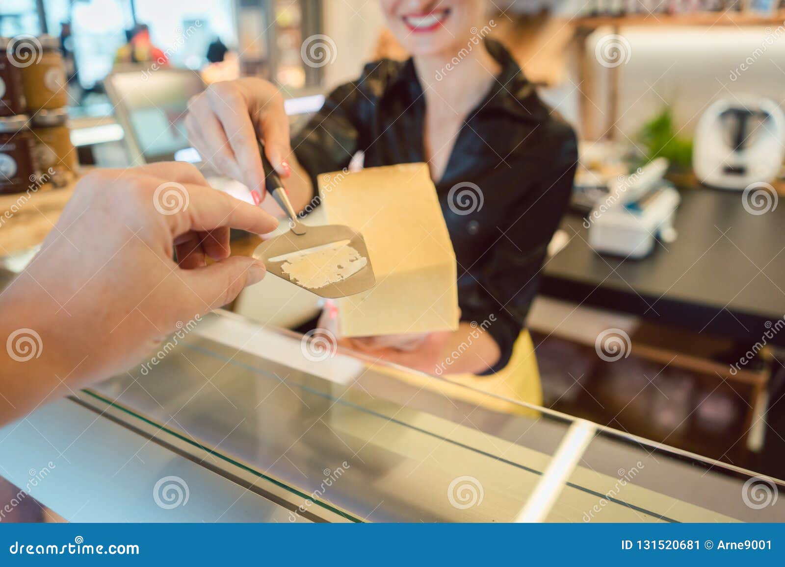 Customer Trying Bit of Cheese at the Deli Counter Stock Image - Image ...
