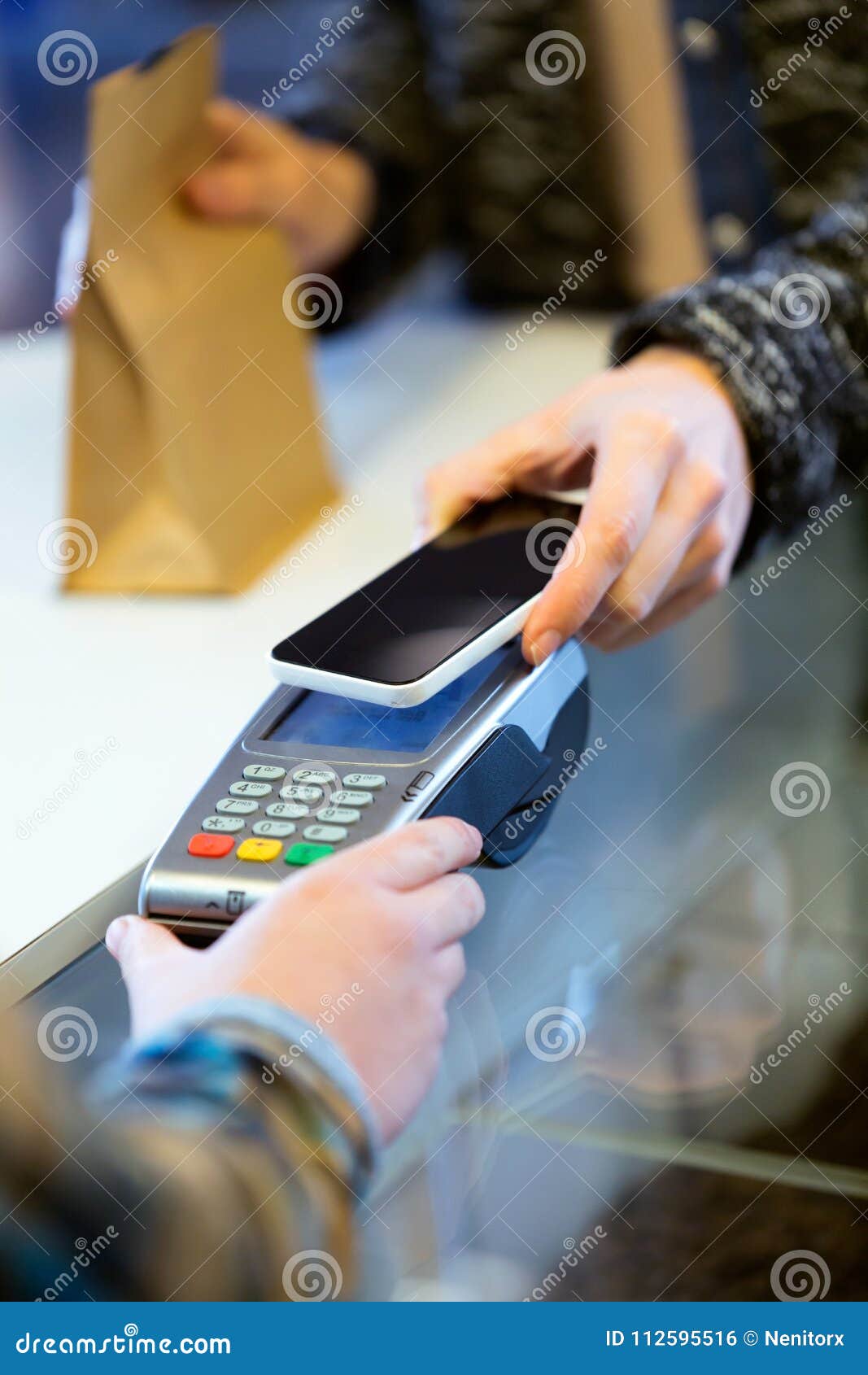 Customer Using Her Smartphone To Make Mobile Payment with Electronic ...