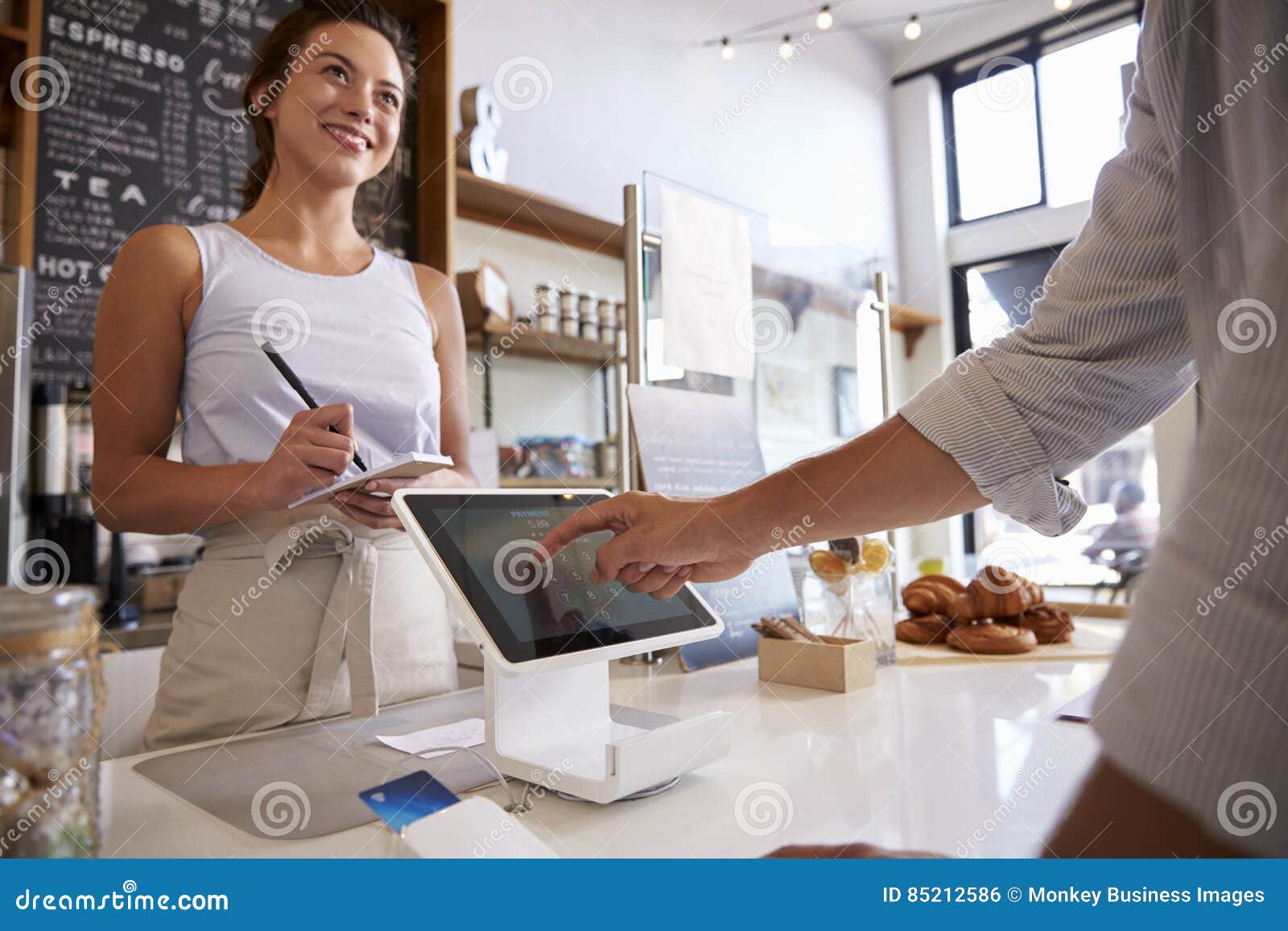 Customer Using Touch Screen To Make Payment at a Coffee Shop Stock ...