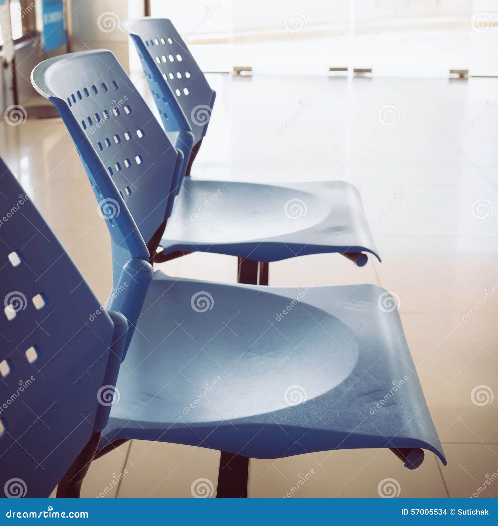 Customer Waiting Area with Rows of Blue Seats Stock Photo - Image of ...