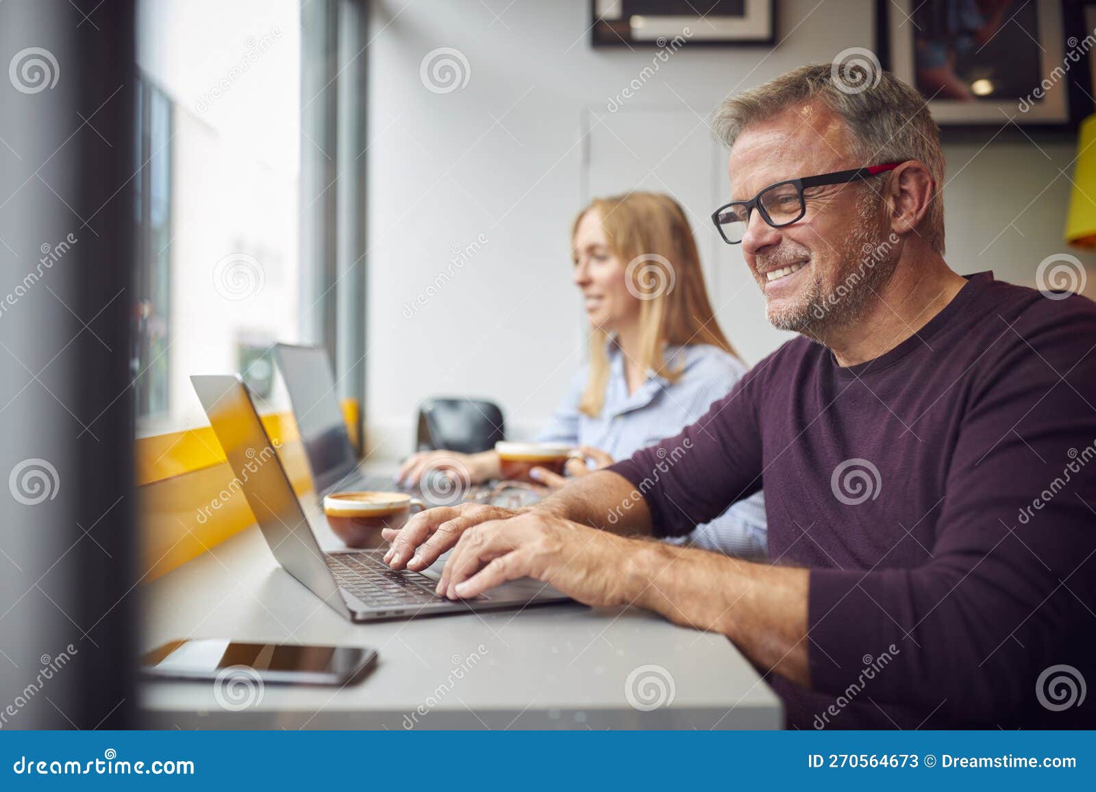 Customers in Coffee Shop Window Working on Laptops Stock Image - Image ...