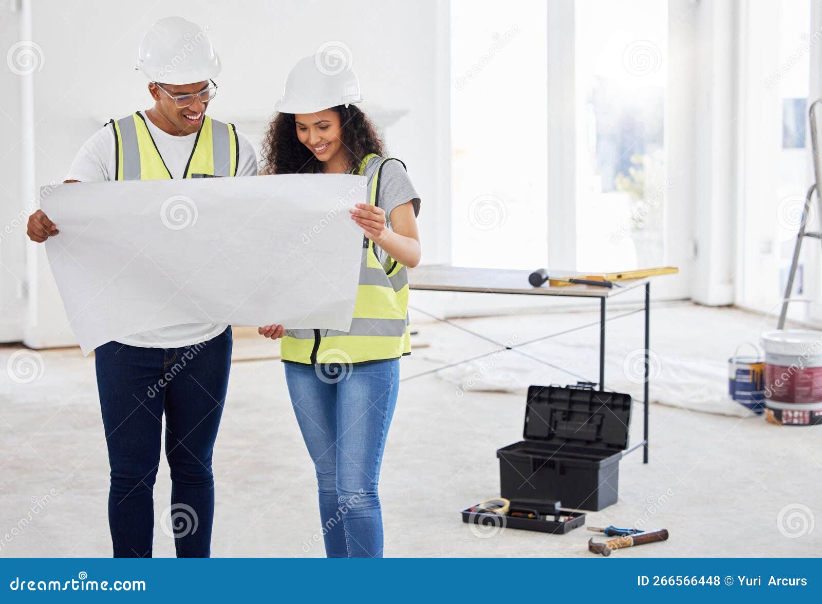 This is the Customers Plan. Two Young Contractors Standing Inside ...