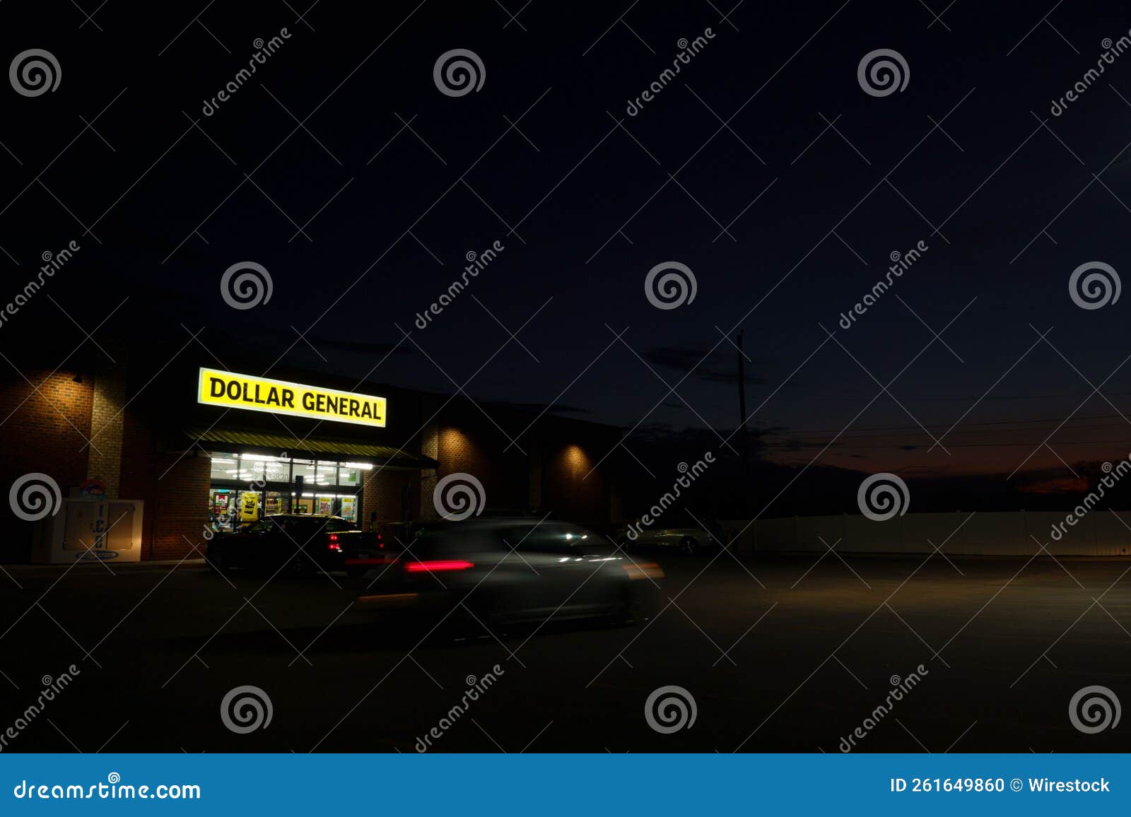 Customers Pulling into the Parking Lot of a Dollar General at Night ...