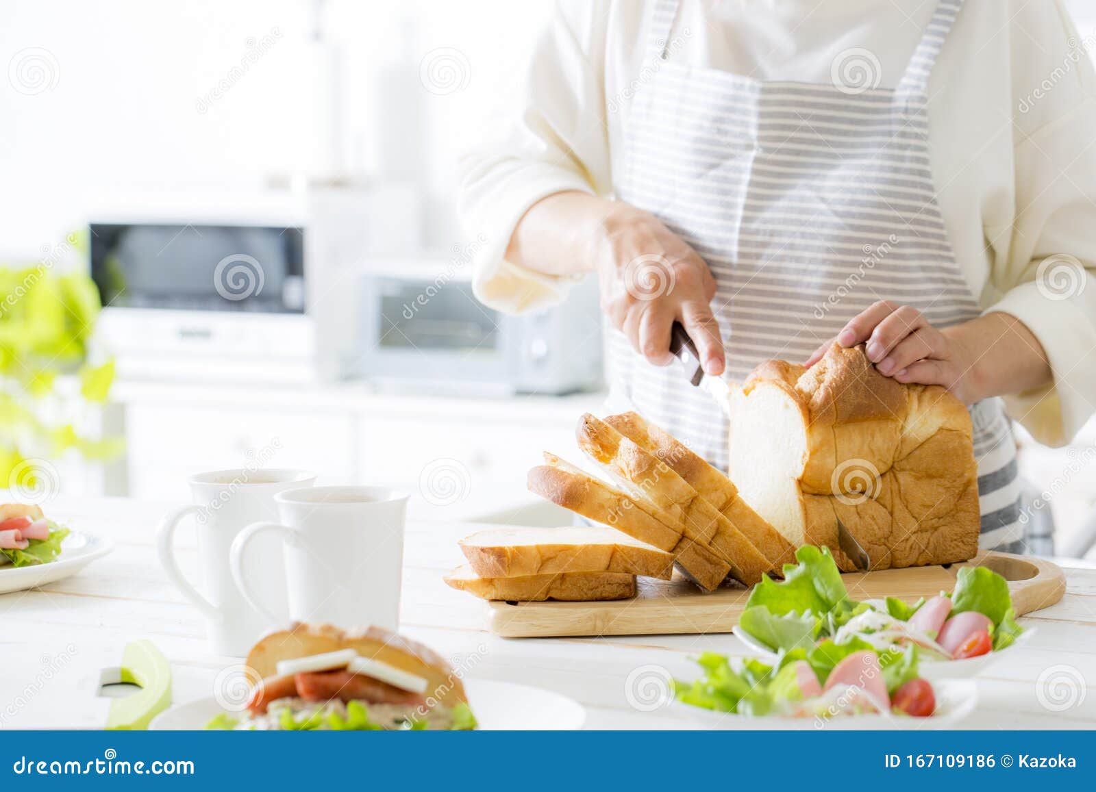Cut bread for breakfast stock photo. Image of woman - 167109186