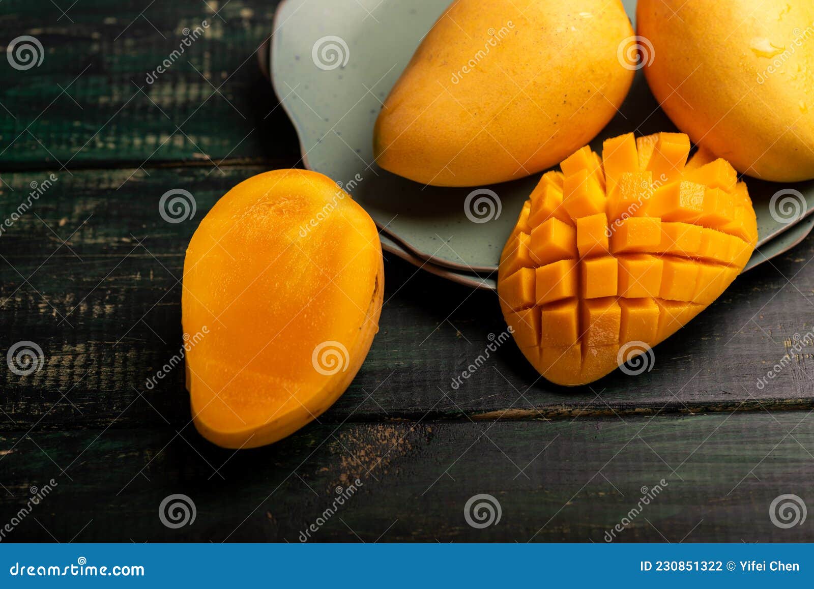 Cut and Complete Mangoes on a Plate in a Dark Environment Stock Photo ...