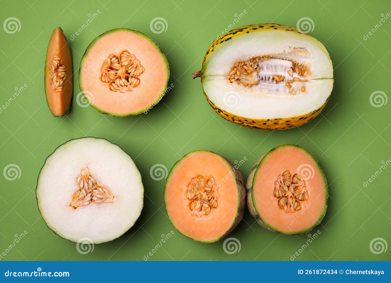 Cut Different Types of Melons on Green Background, Flat Lay Stock Photo ...