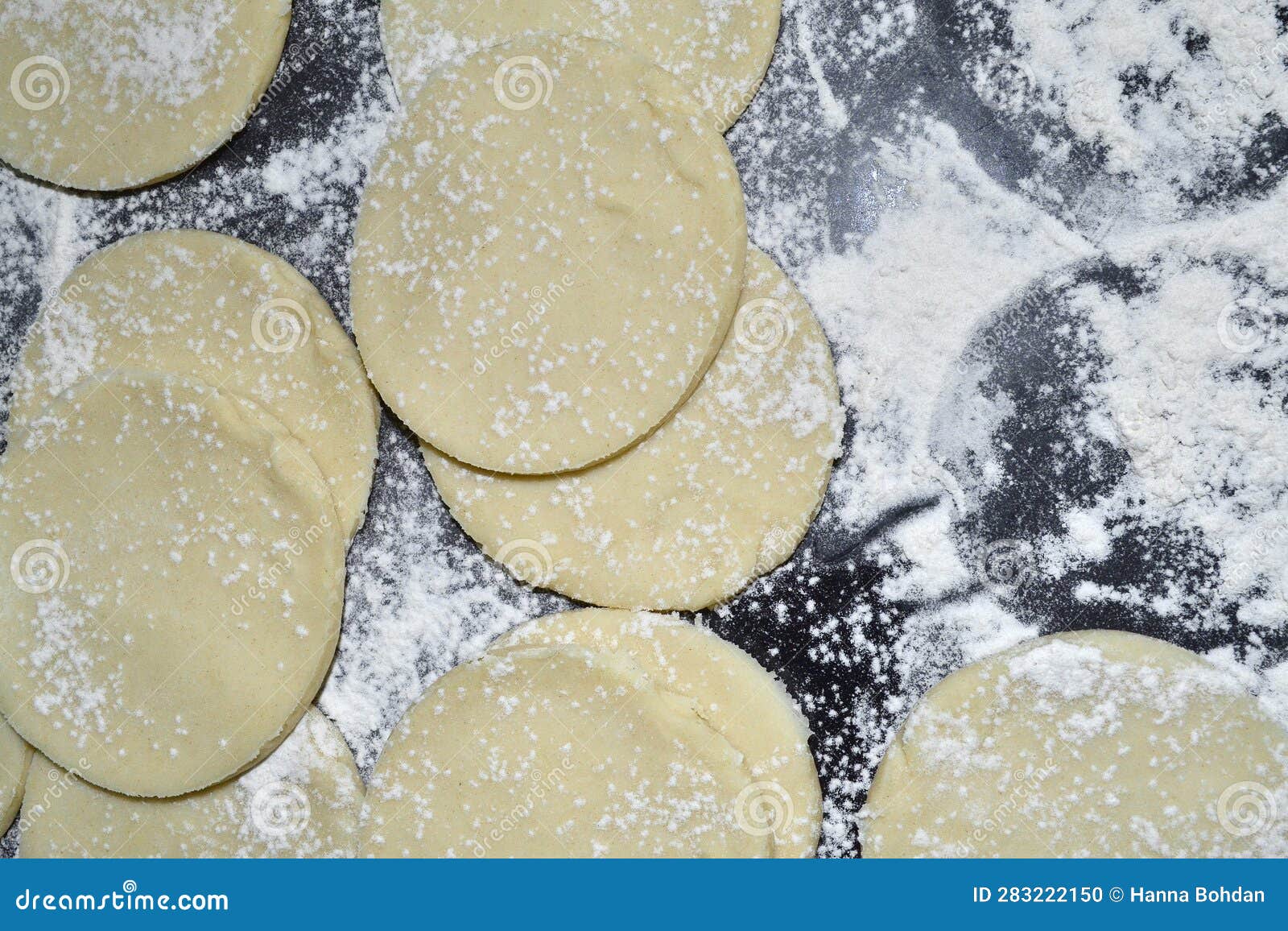 Cut Dough for Dumplings in Flour Lies on a Black Table Stock Photo ...