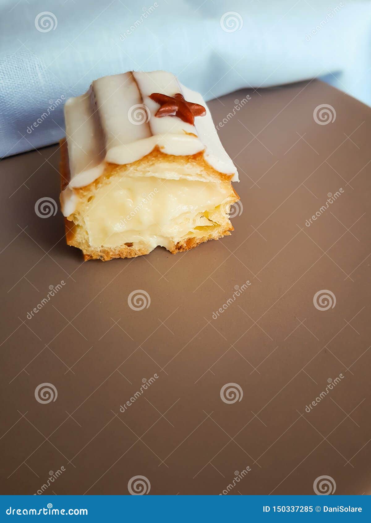 The Cut of Eclair with Vanilla Cream Covered with White Chocolate Glaze ...