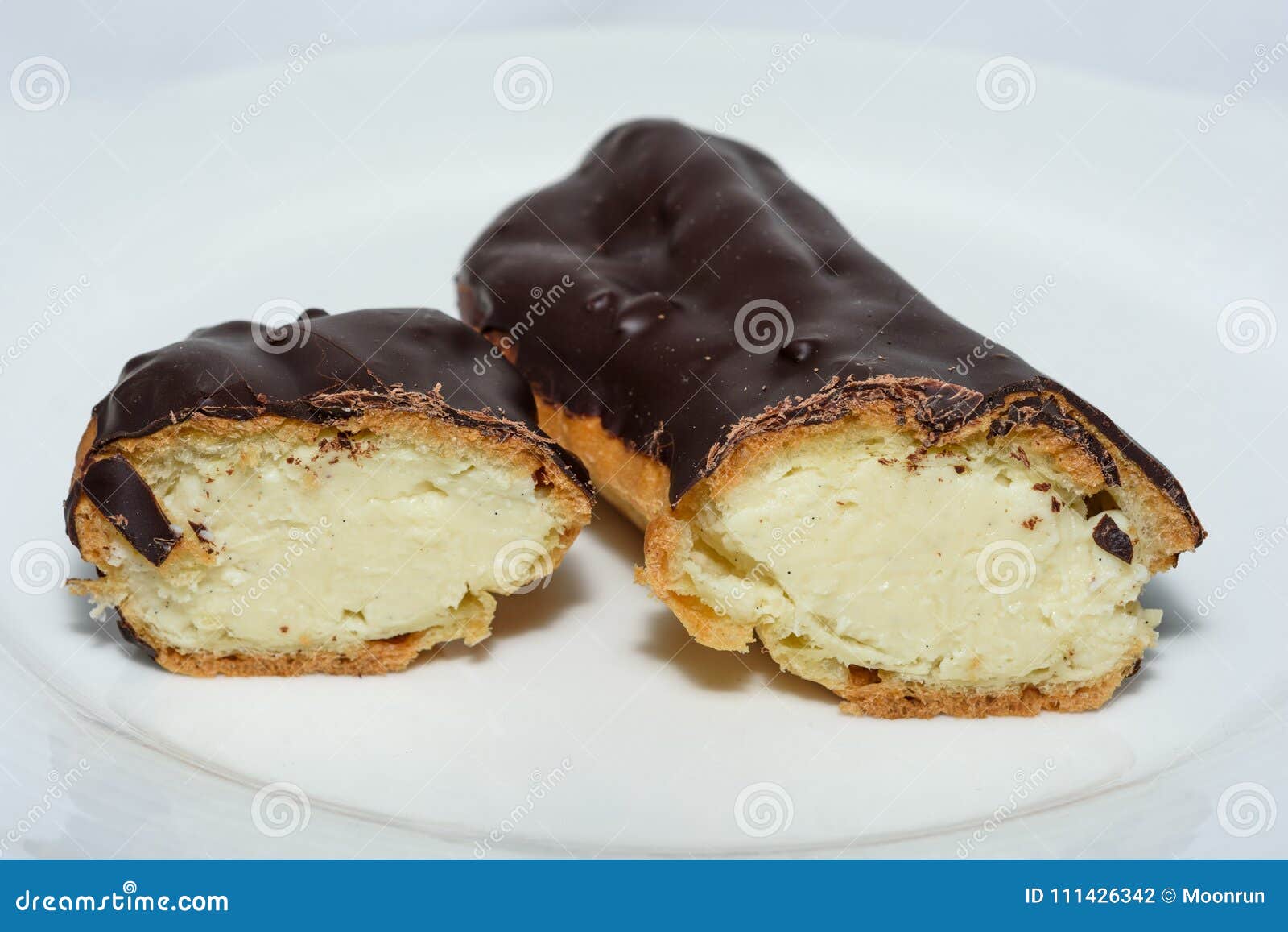 Cut Eclair on White Background Stock Photo - Image of pastry, close ...
