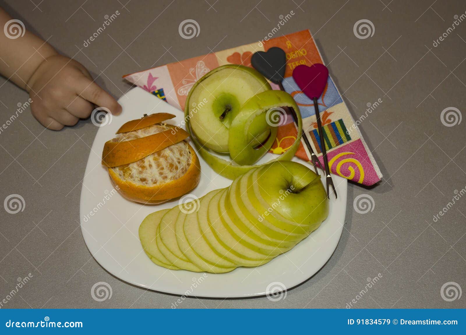 The Cut Fruit on a Plate Apple Orange the Child`s Handle Stock Image ...