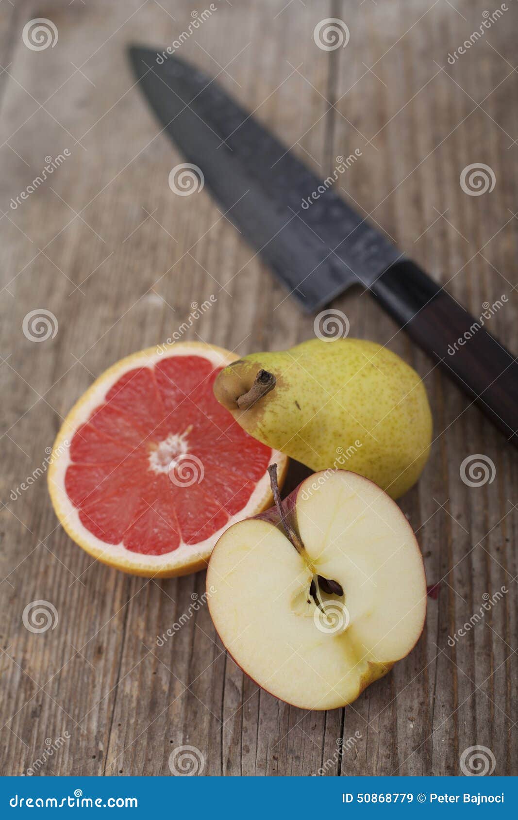 Cut Fruit on Wooden Surface with Knife Stock Image - Image of wood ...