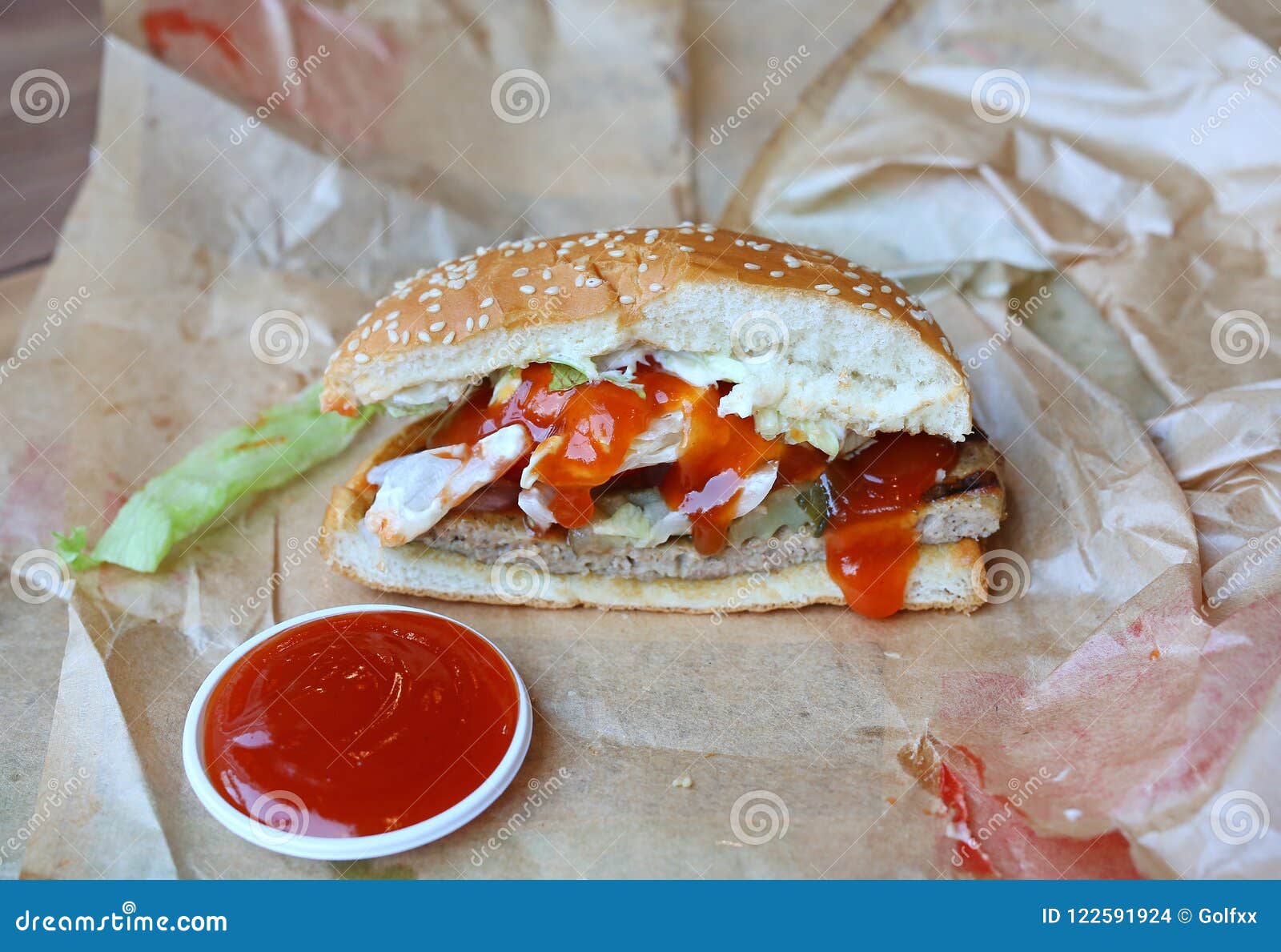 Cut Half Beef Burger on Paper Stock Photo - Image of leaf, fries: 122591924