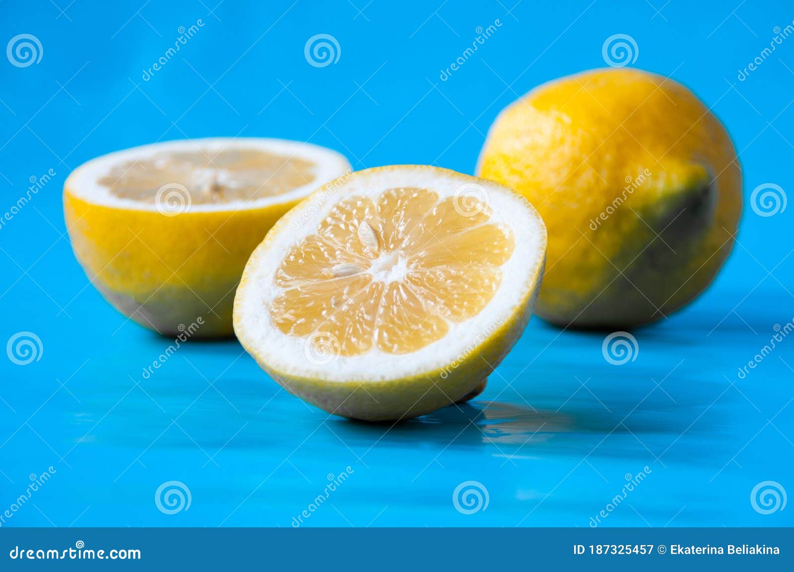 Cut Lemon into Pieces on a Blue Background Stock Image - Image of ...