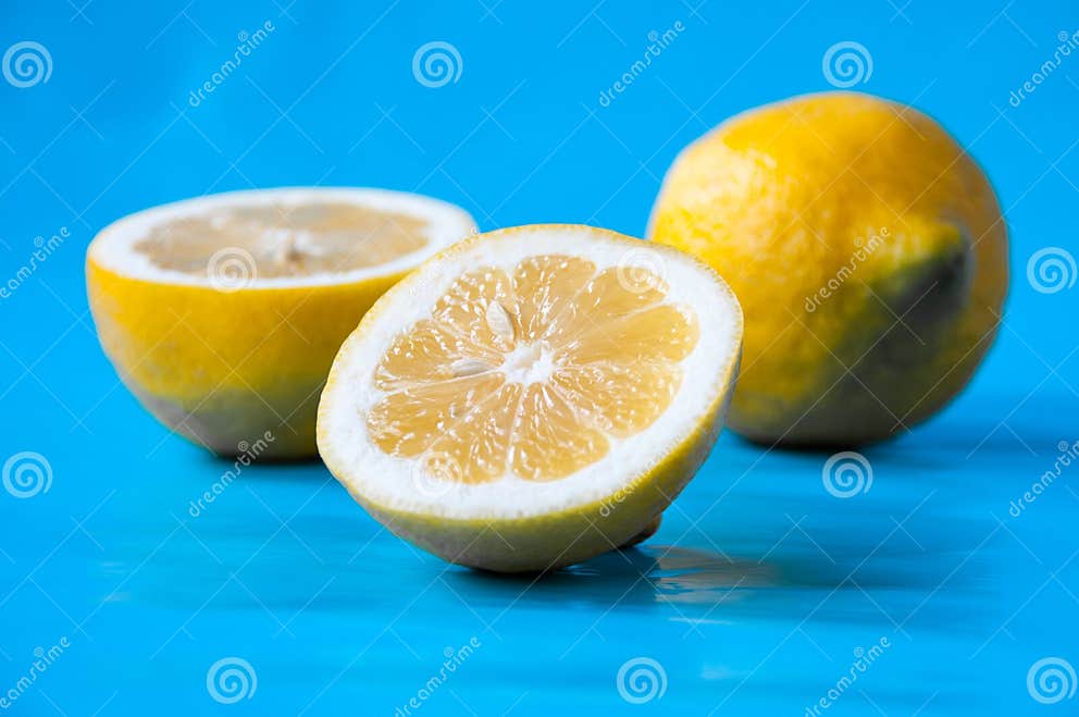 Cut Lemon into Pieces on a Blue Background Stock Image - Image of ...