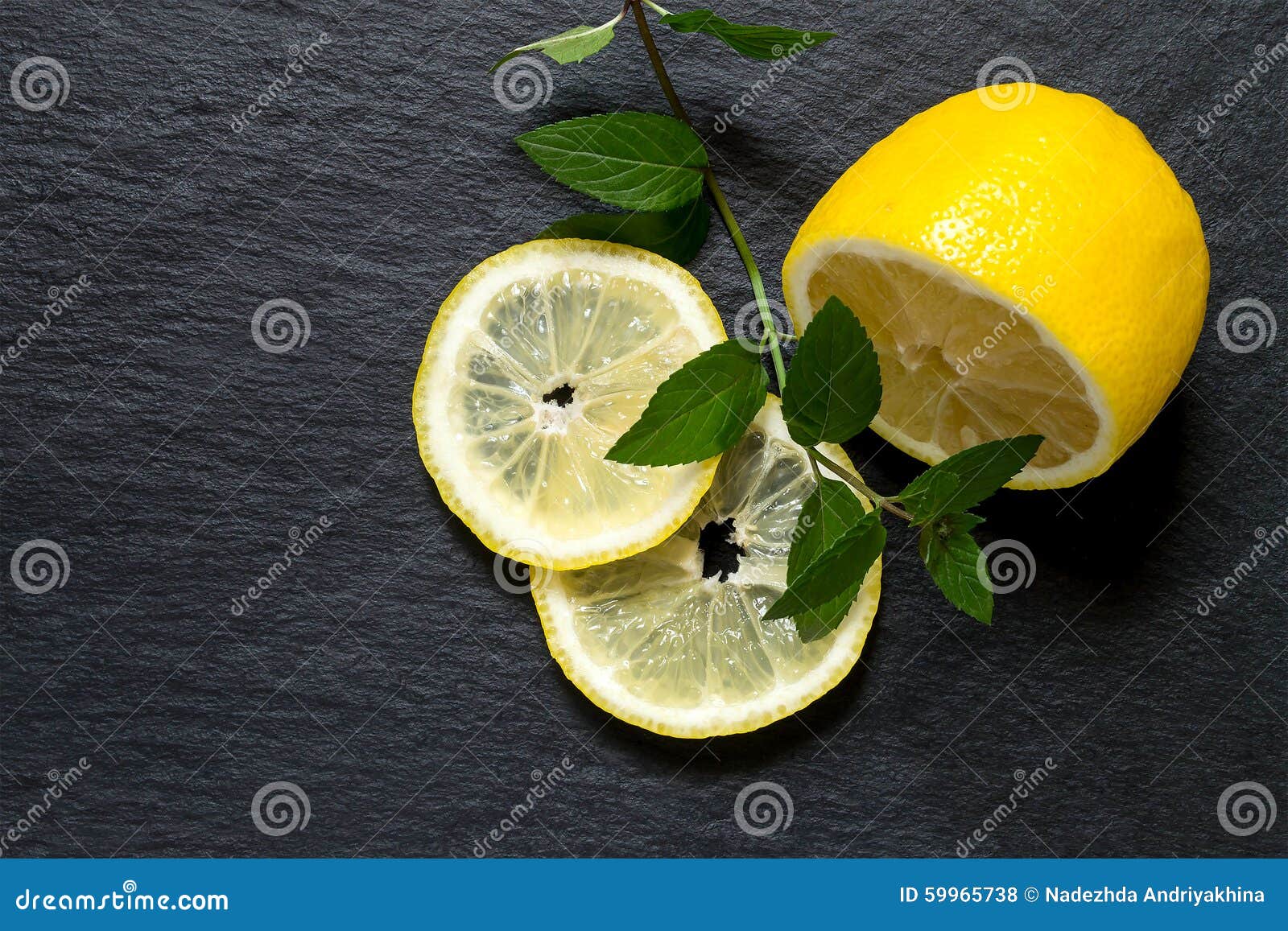Cut Lemon with a Sprig of Mint on a Slate Blackboard Stock Photo ...