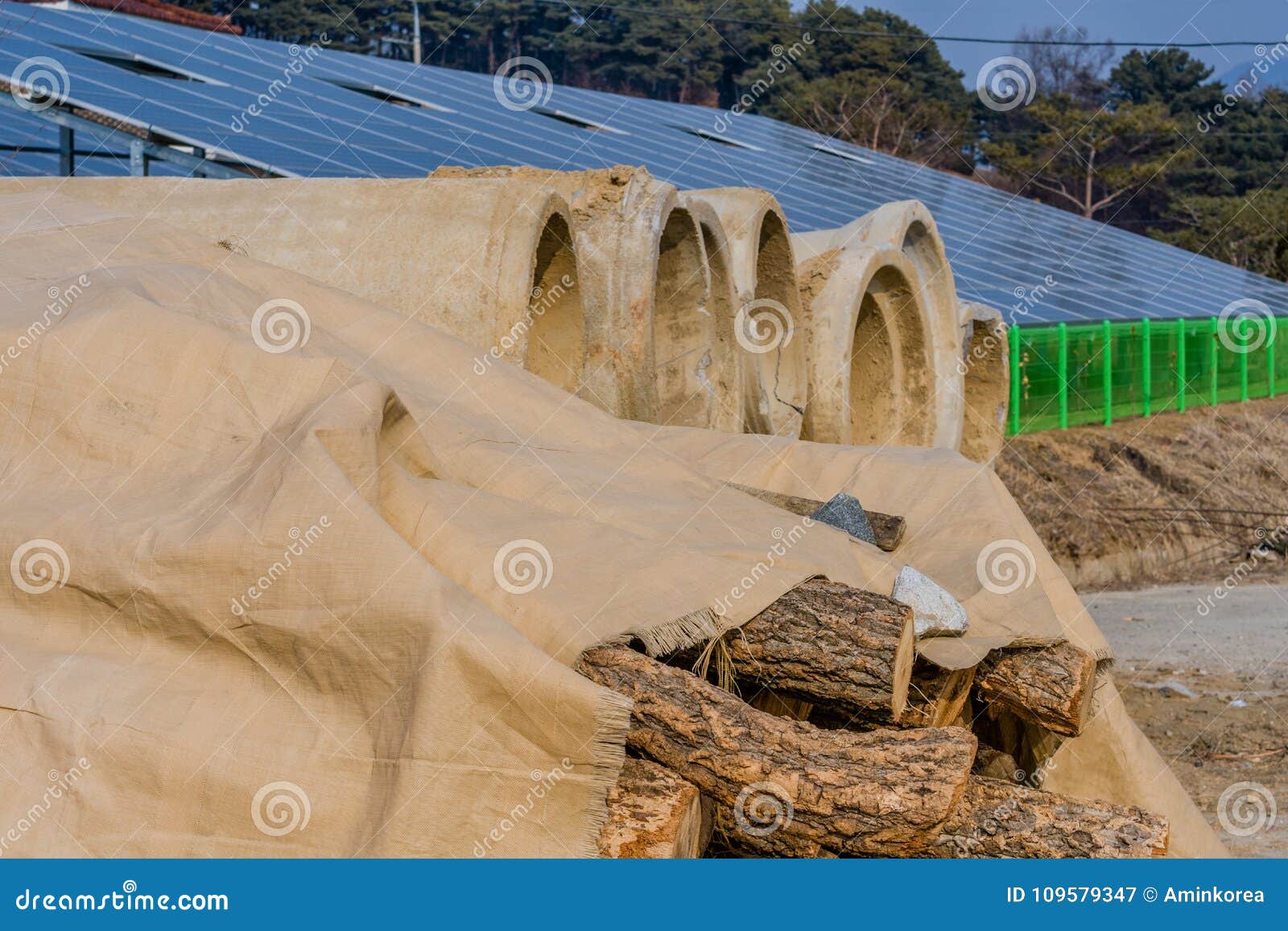 Cut Logs and Precast Concrete Culvert Sections Stock Image - Image of ...