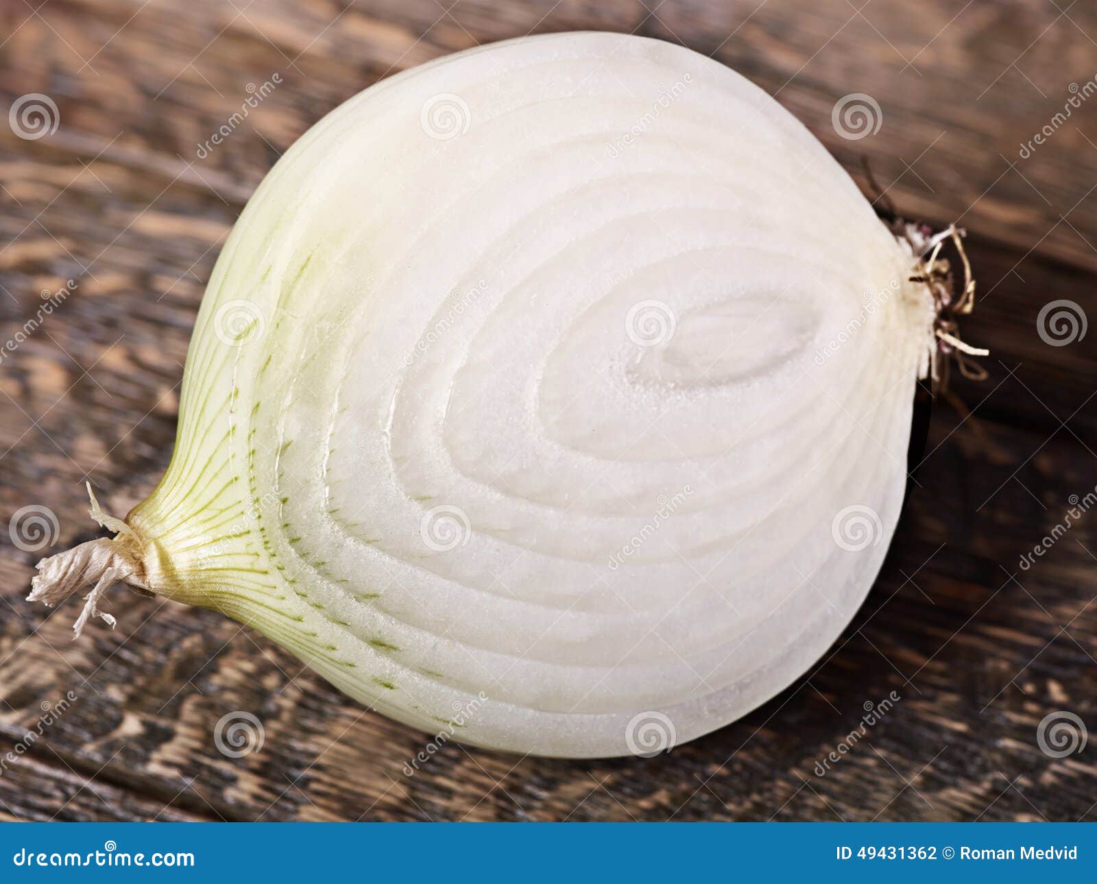 Cut onion on wooden back stock photo. Image of segment - 49431362
