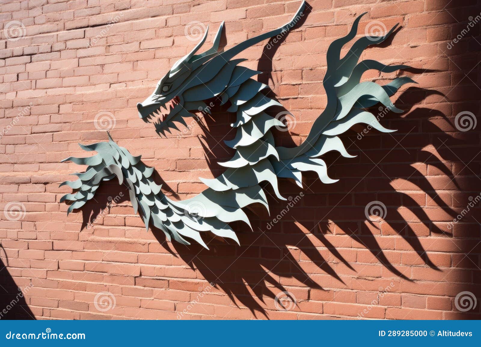 Cut-out Paper Dragon with Shadow Dancing on a Brick Wall Stock Photo ...