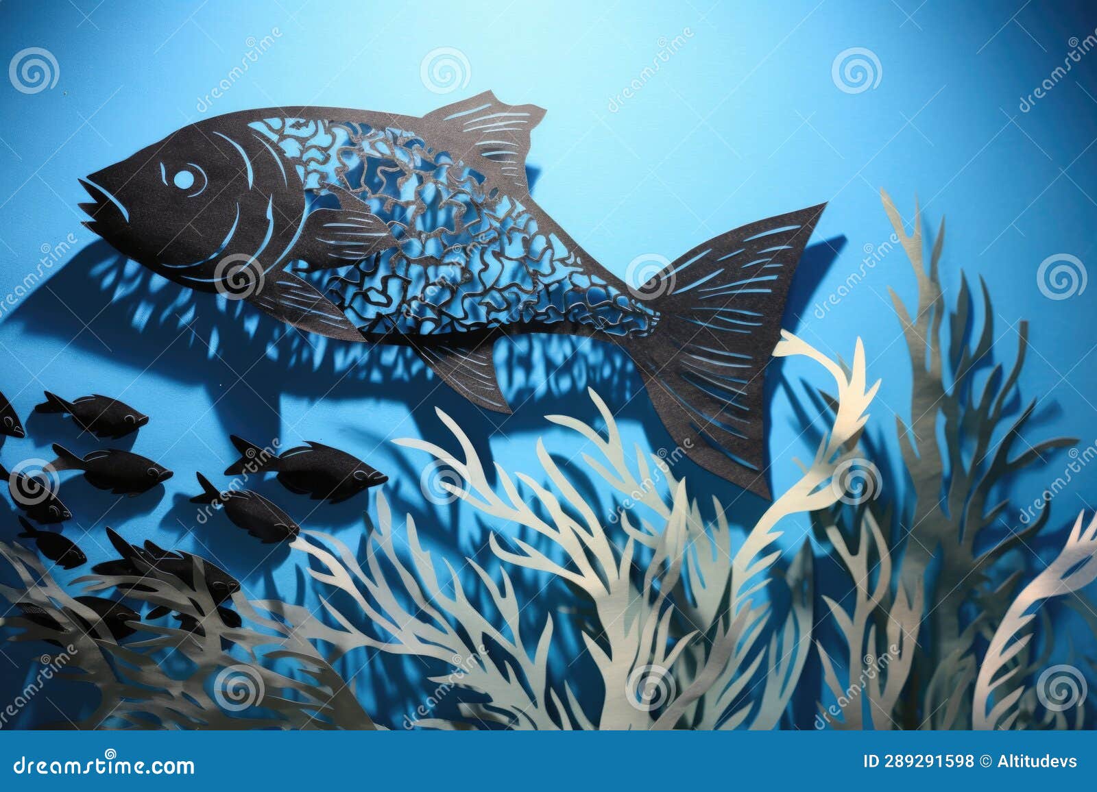 Cut-out Paper Fish Casting Shadows on Blue Textured Paper Stock Photo ...