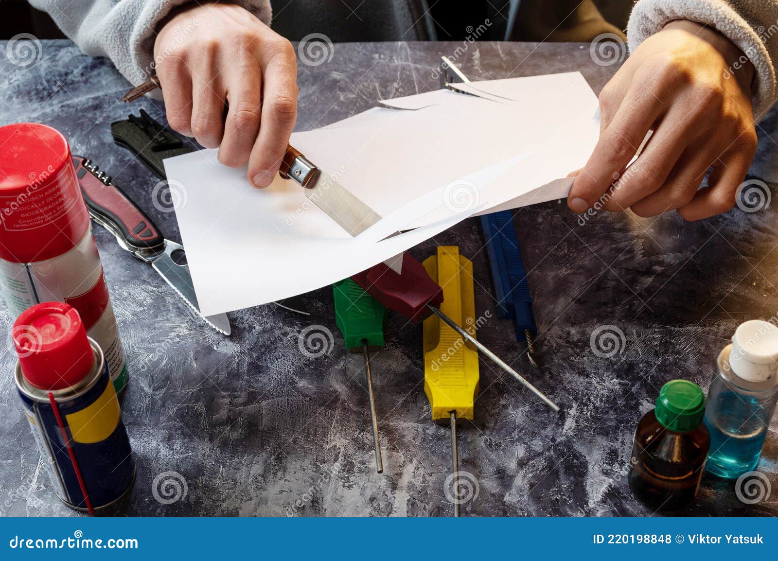 The Master Cuts the Paper with a Knife. Checking the Sharpness of the ...