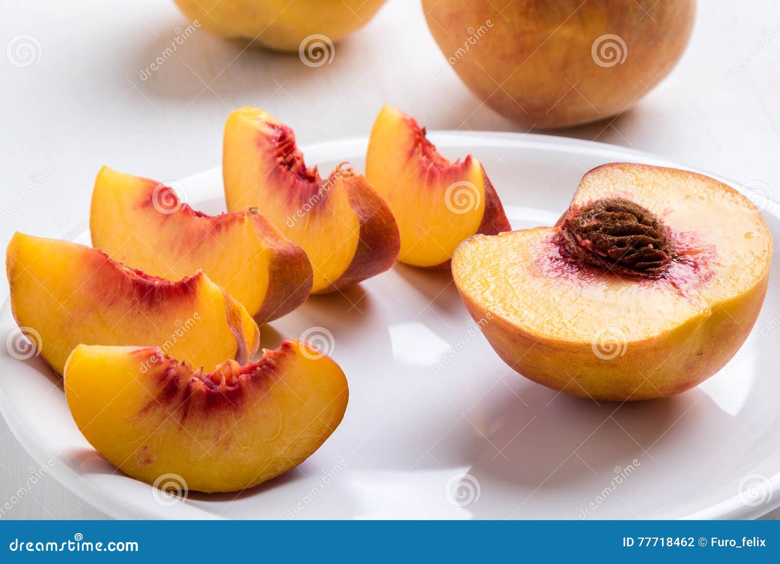 Cut peach on white plate stock photo. Image of fresh - 77718462