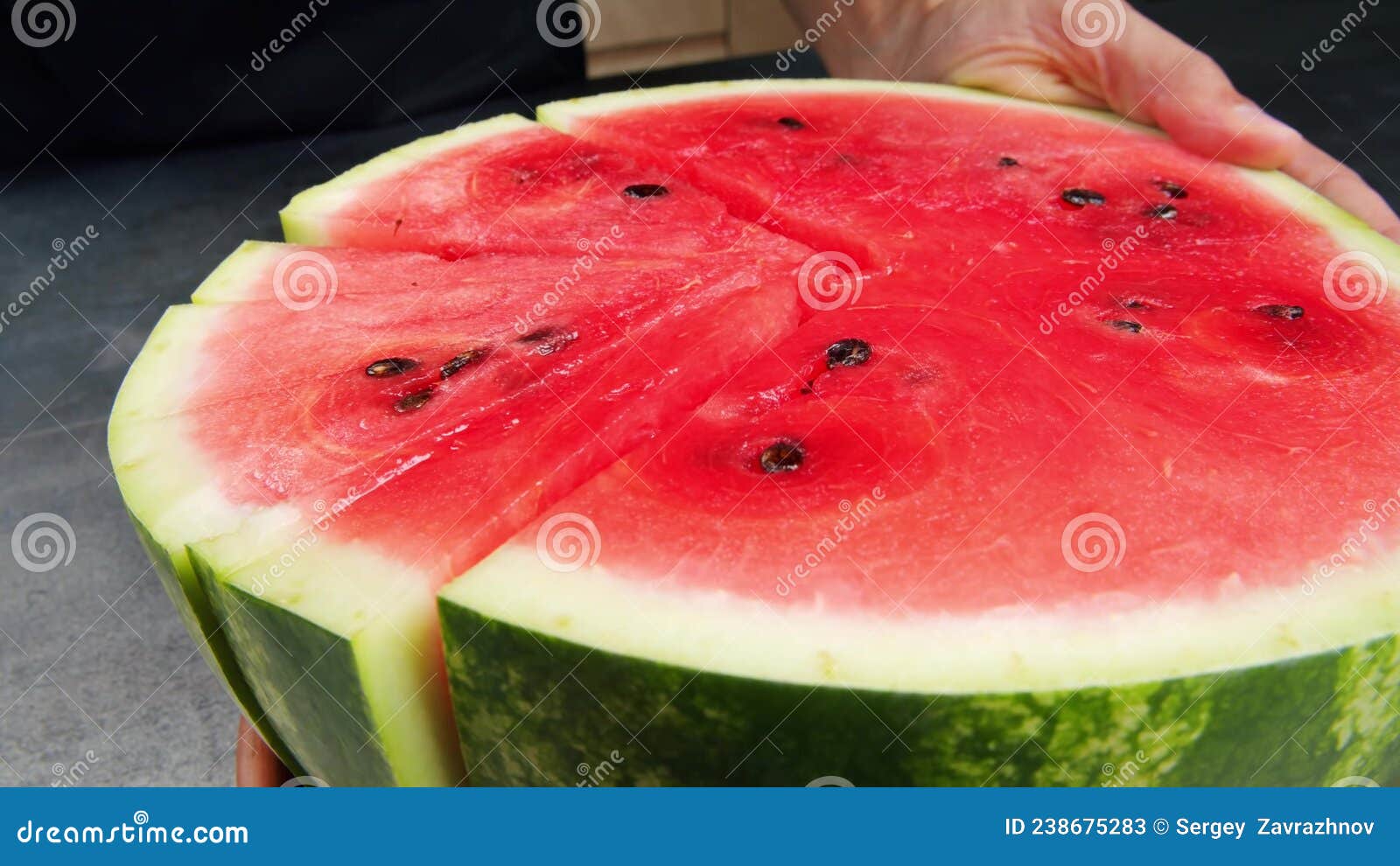 Cut Triangular Pieces of Ripe Watermelon on a Wooden Board on a Gray ...