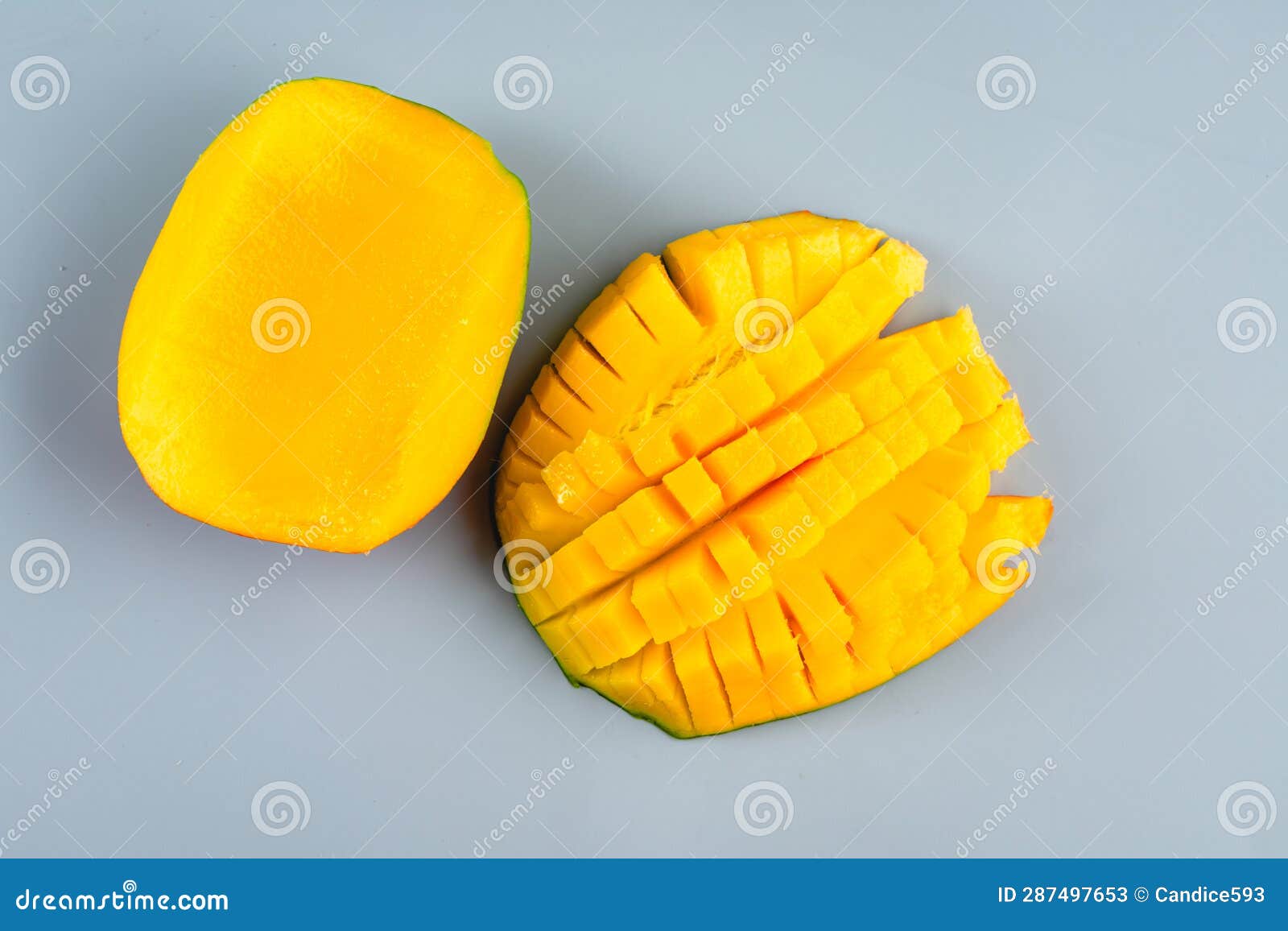 Cut and Uncut Cored Mango Halves on a Blue Background Stock Image ...