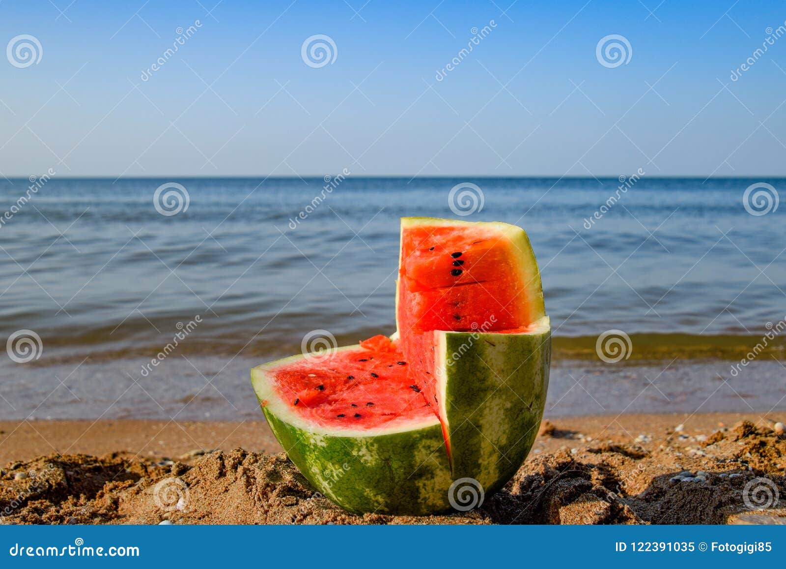 The Cut Watermelon Lies on the Seashore. Watermelon in the Sea Stock ...