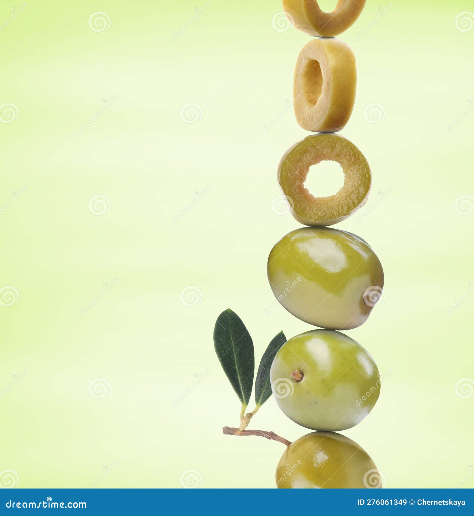 Cut and Whole Olives with Leaves on Yellowish Green Gradient Background ...