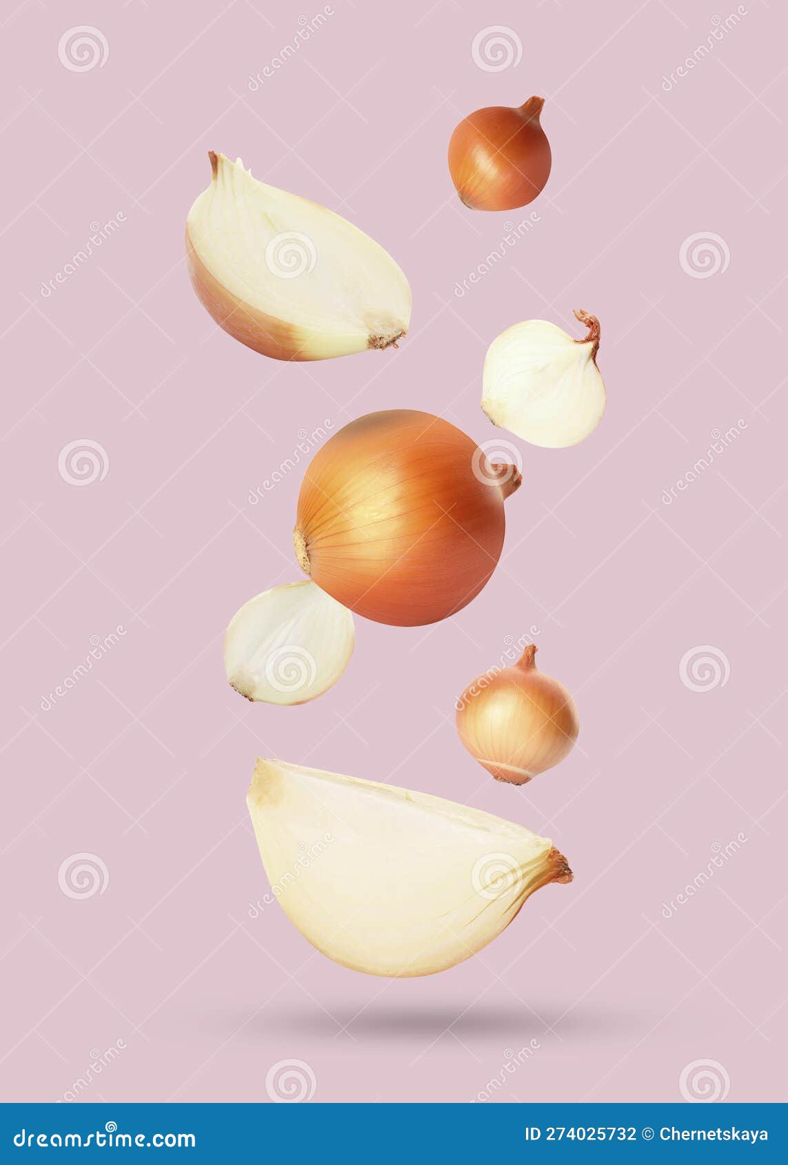Cut and Whole Onions Falling on Pastel Pink Background Stock Photo ...