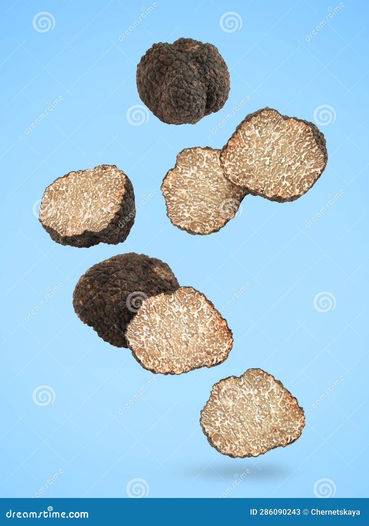 Cut and Whole Truffles Falling on Light Blue Background Stock Image ...